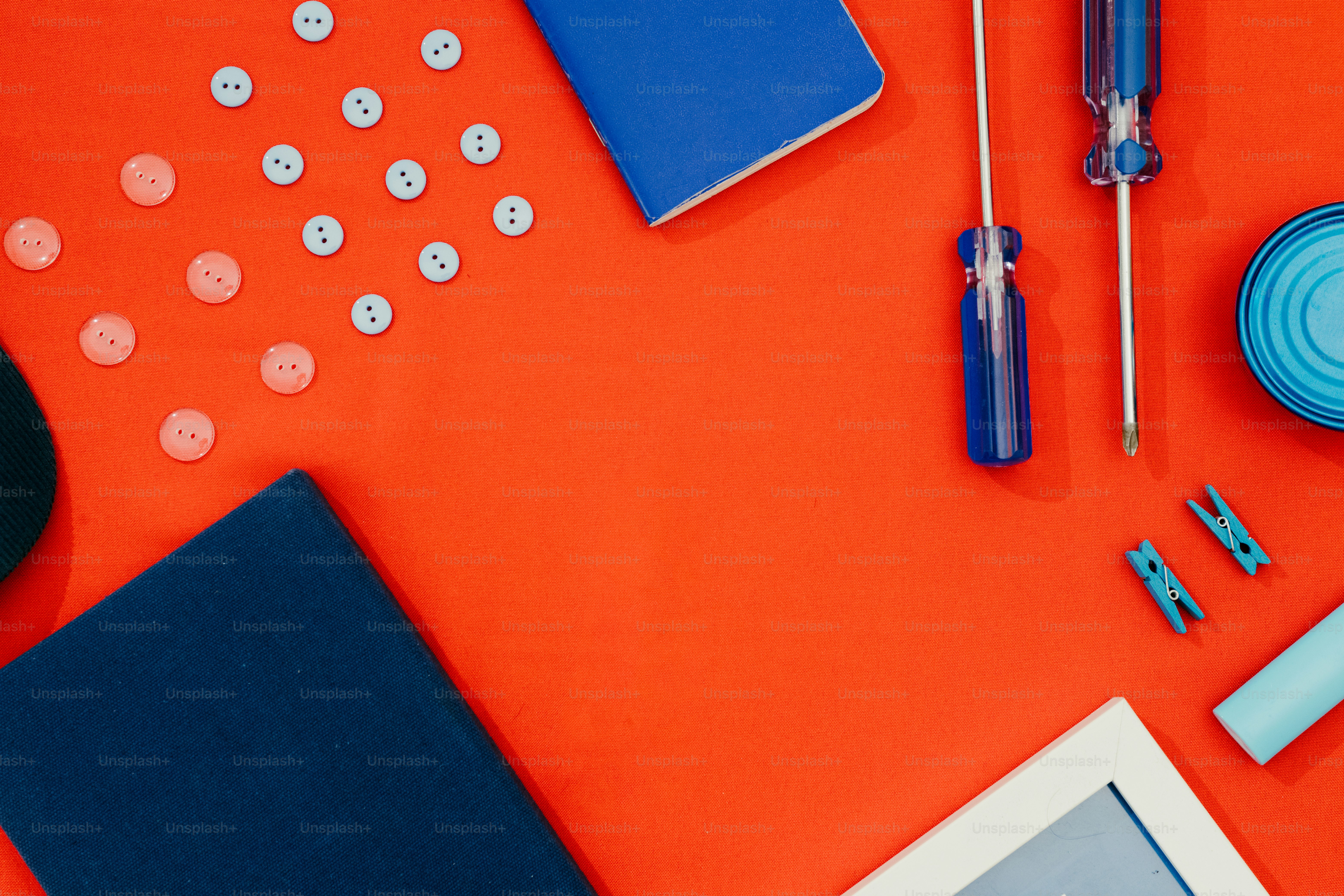 Blue tools and objects are arranged on red background. photo ...