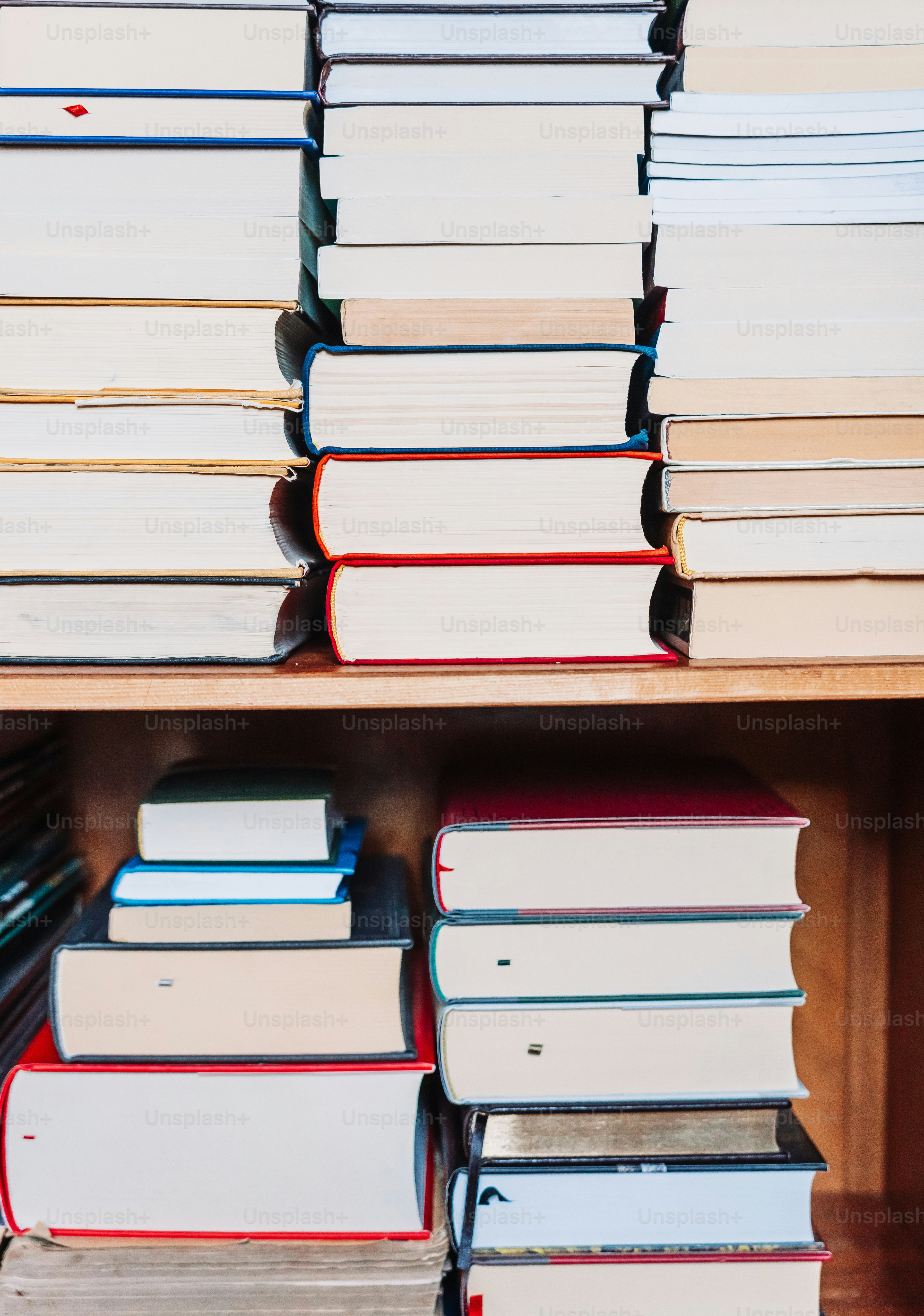 Books are stacked neatly on shelves. photo – Books Image on Unsplash