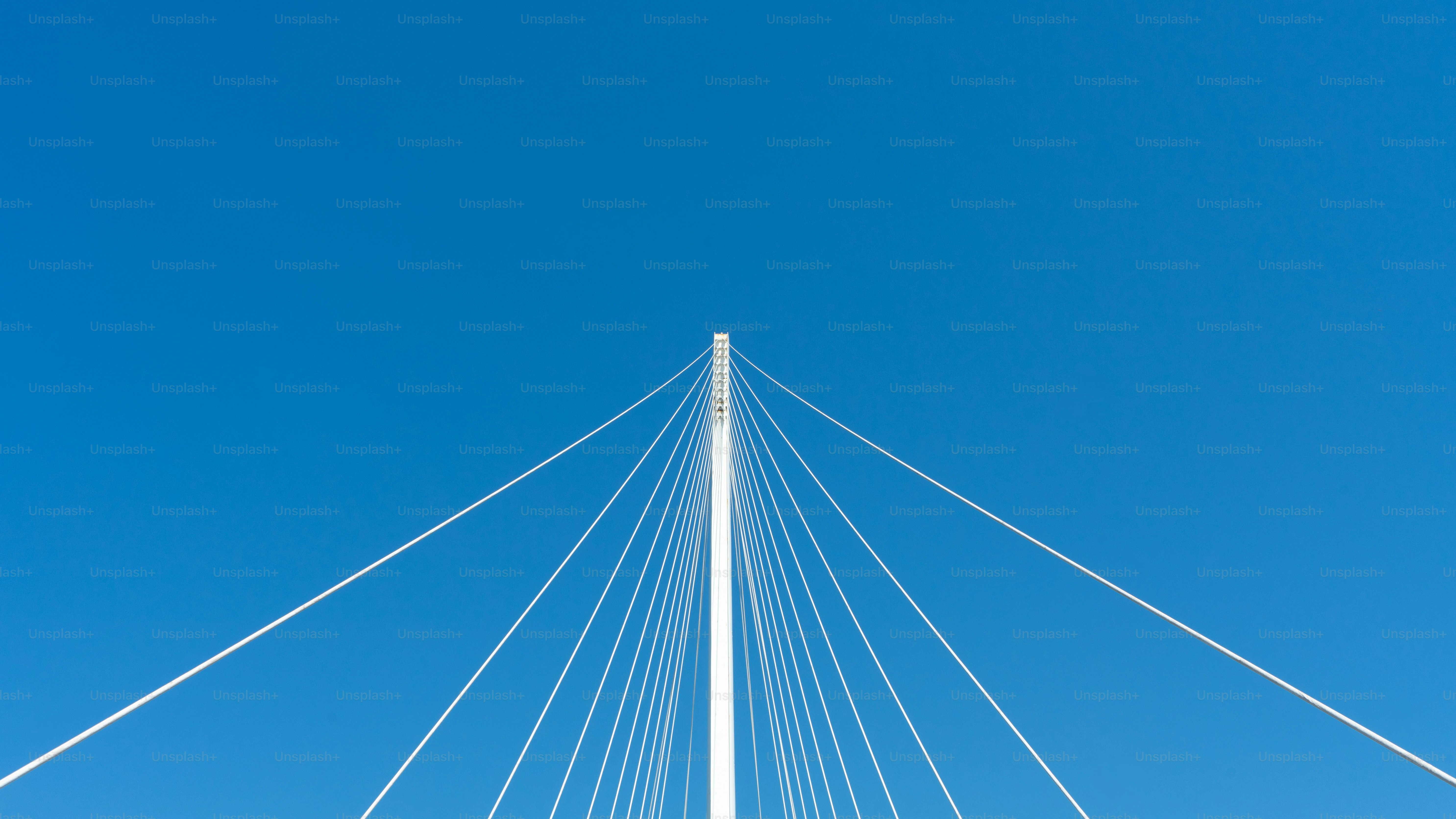 Bridge cables reach towards a clear, blue sky. photo – Minimal Image on ...
