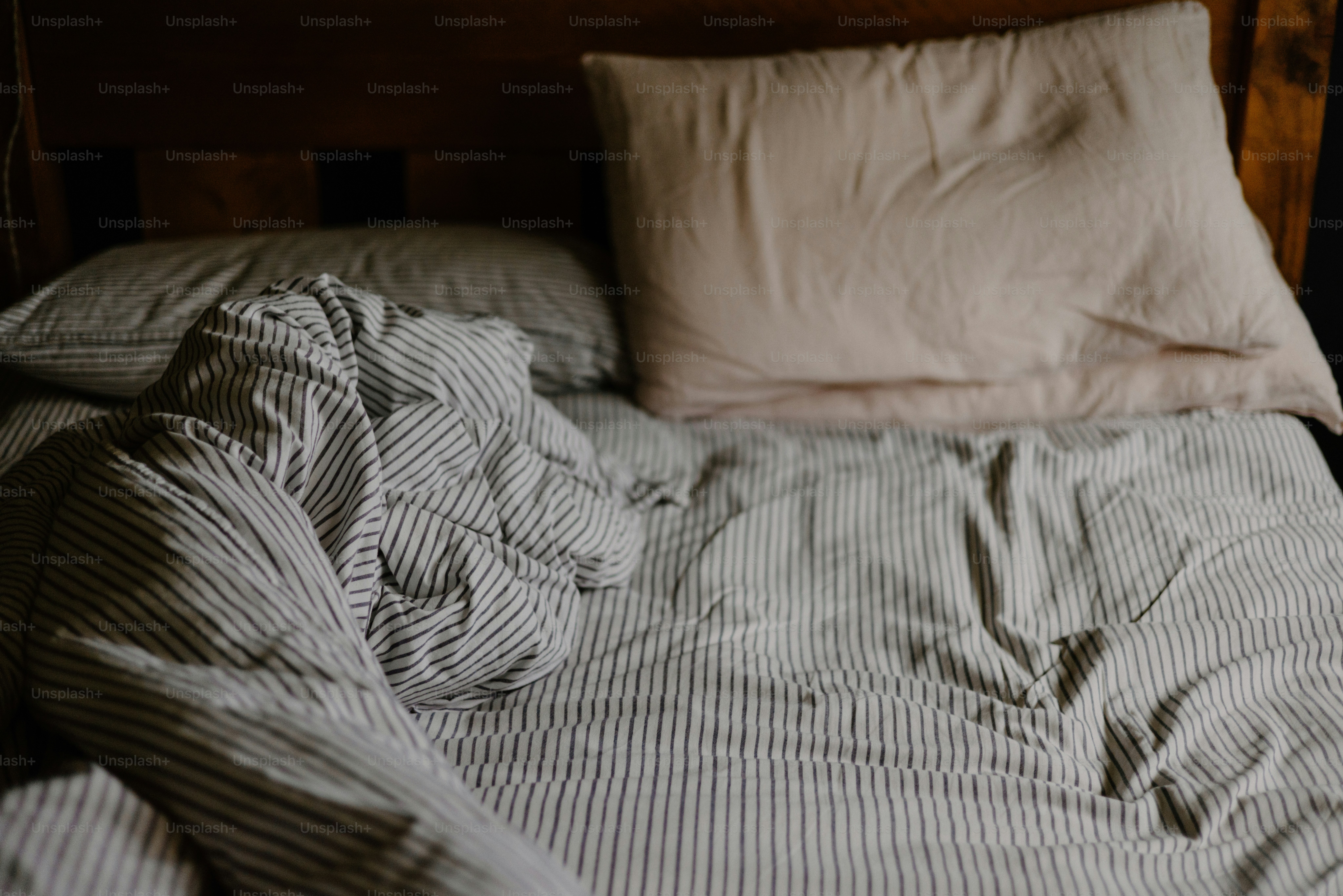Unmade bed with pillows and rumpled sheets. photo – Bedroom Image on ...