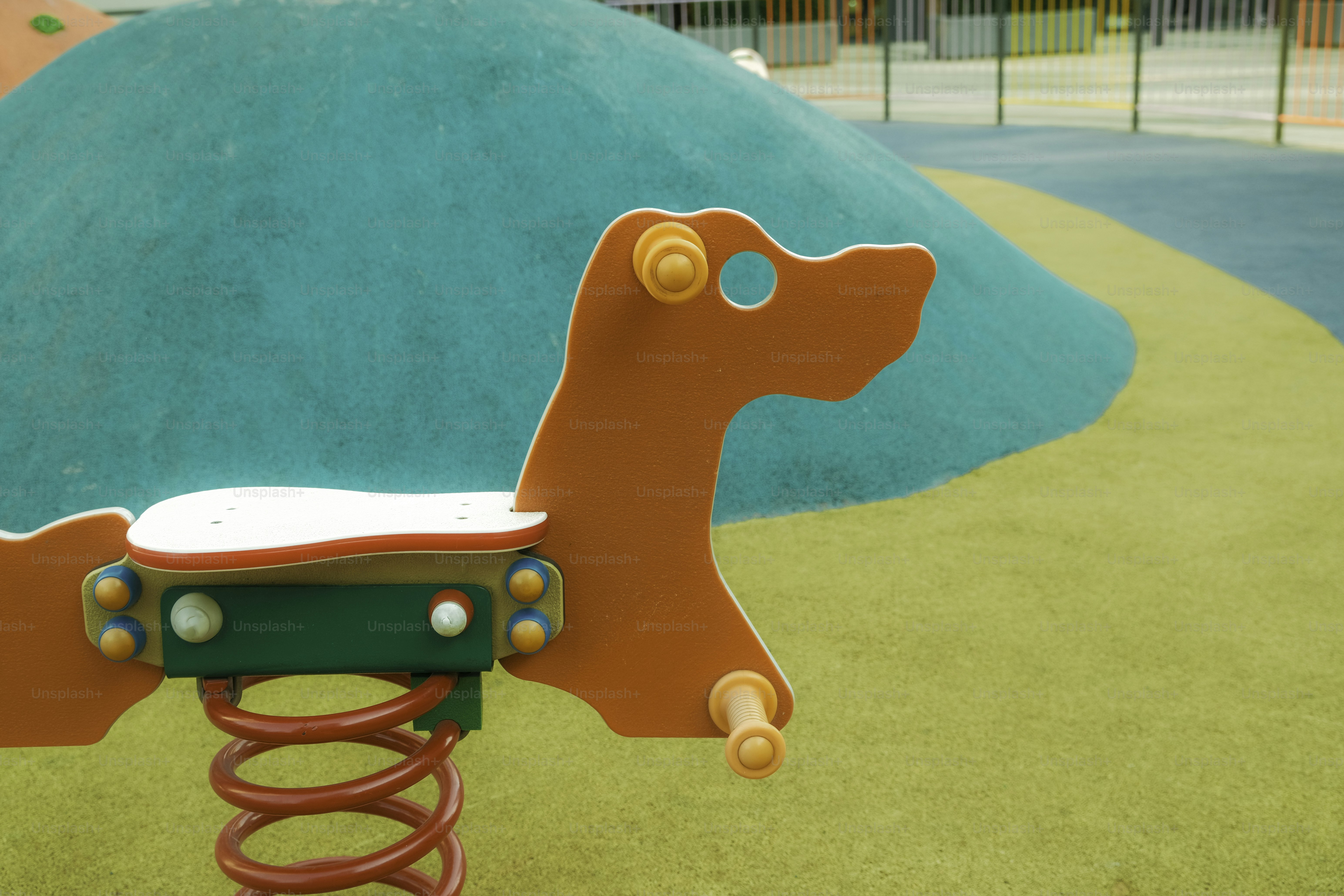 A colorful see-saw on a playground. photo – Joy Image on Unsplash