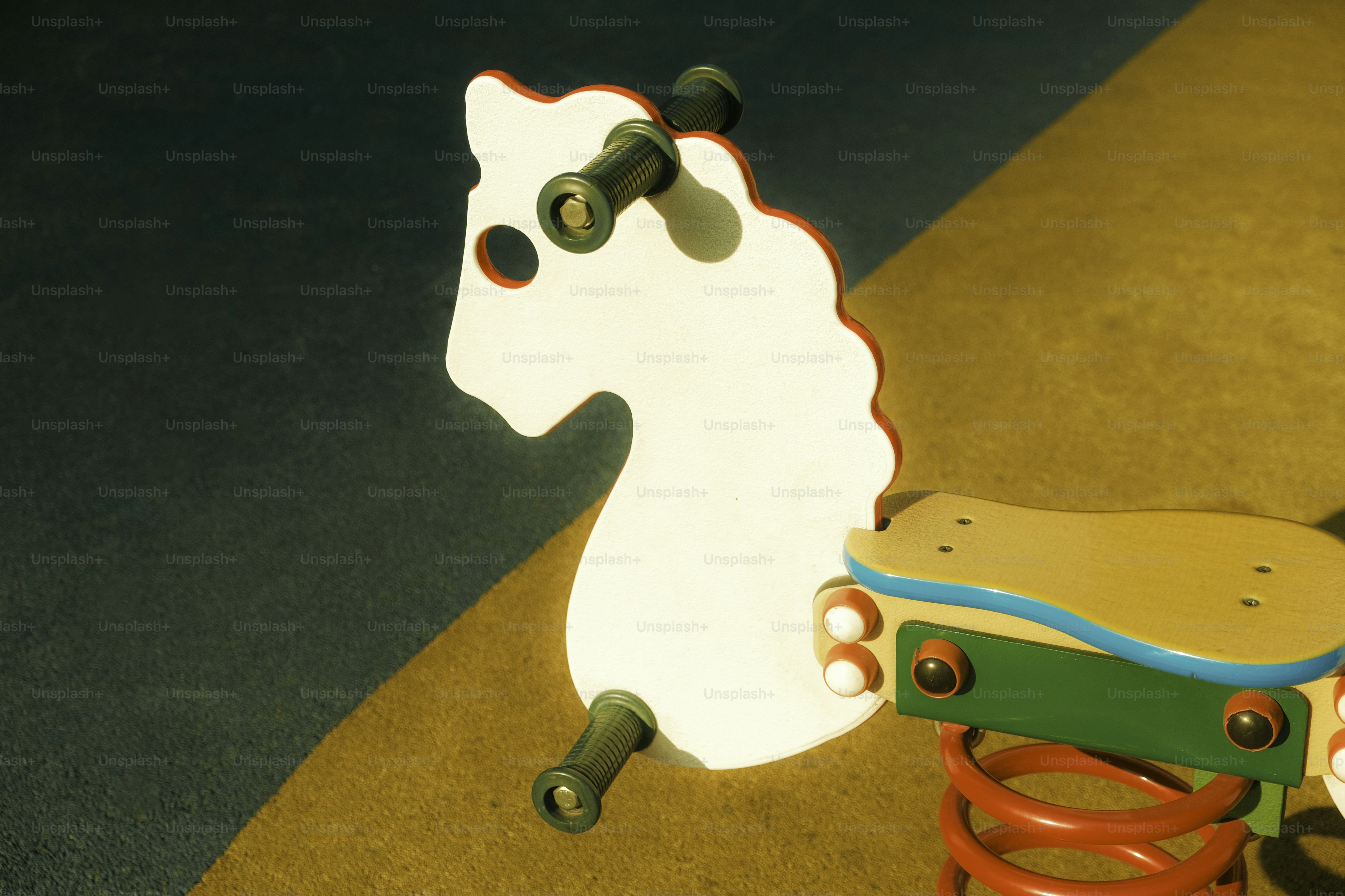 A white horse spring rider at the playground. photo – Joy Image on Unsplash