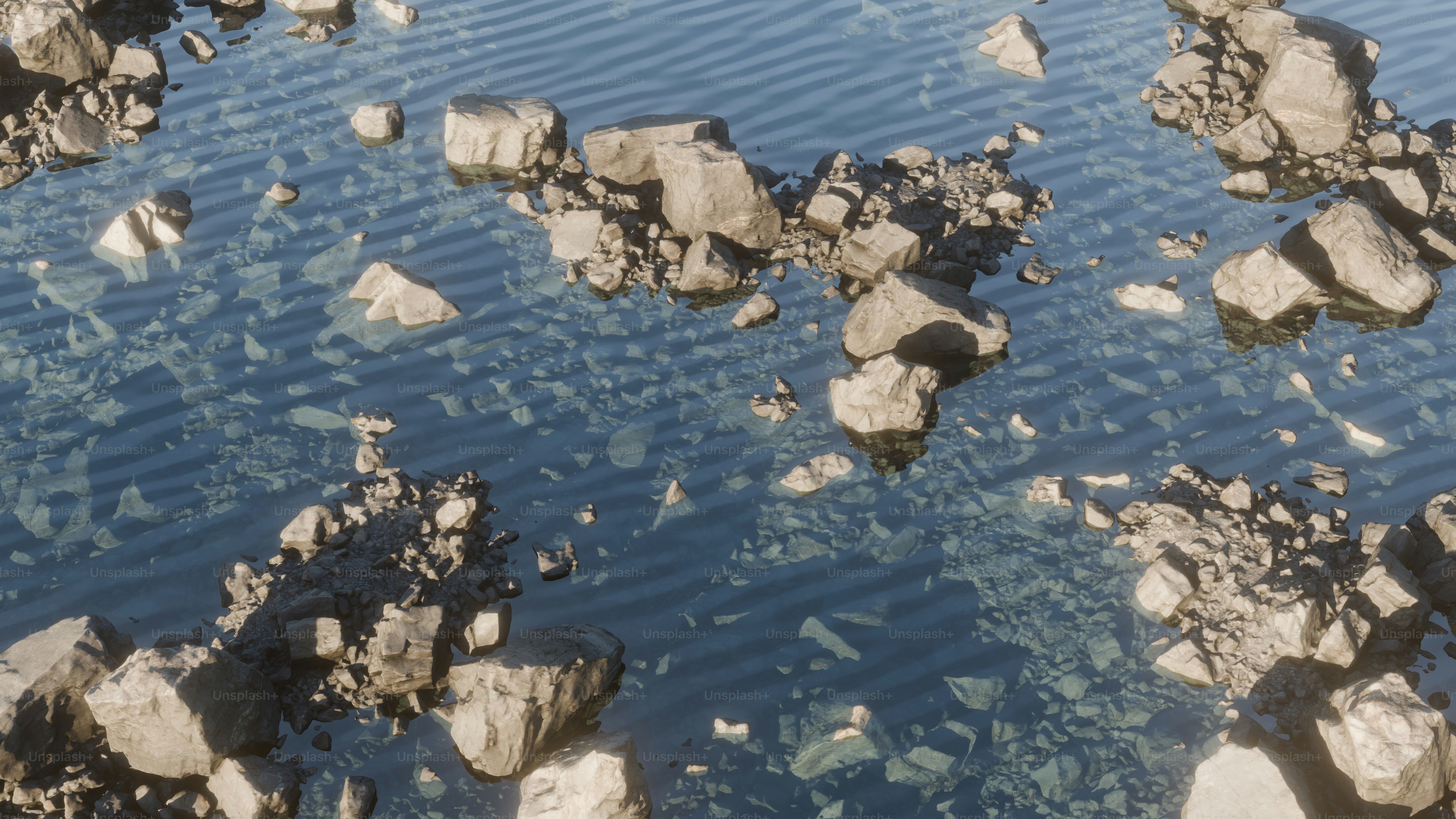 Rocks float in clear, shallow water. photo – Render Image on Unsplash