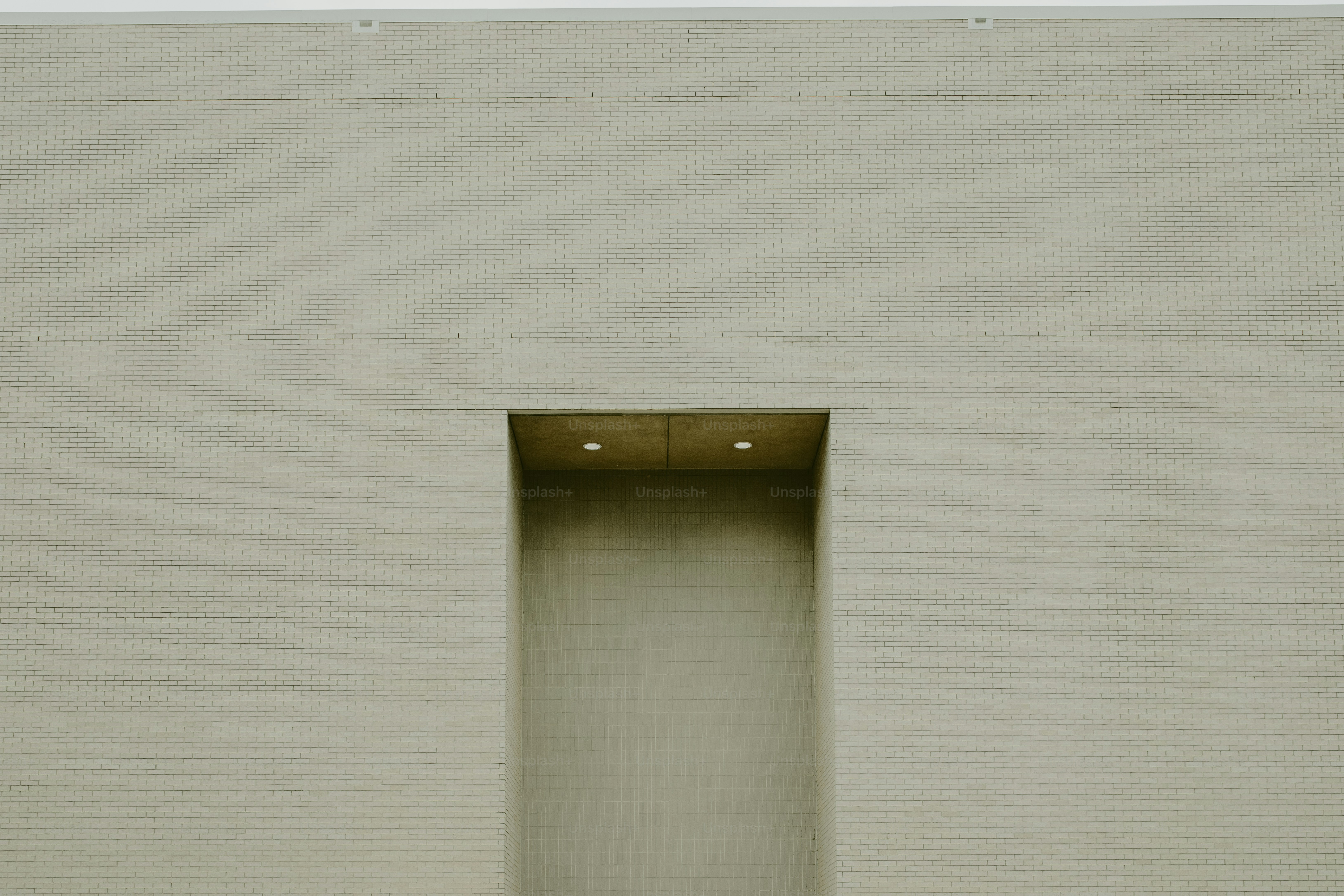 A minimalist wall with a recessed, lit space. photo – Architecture ...
