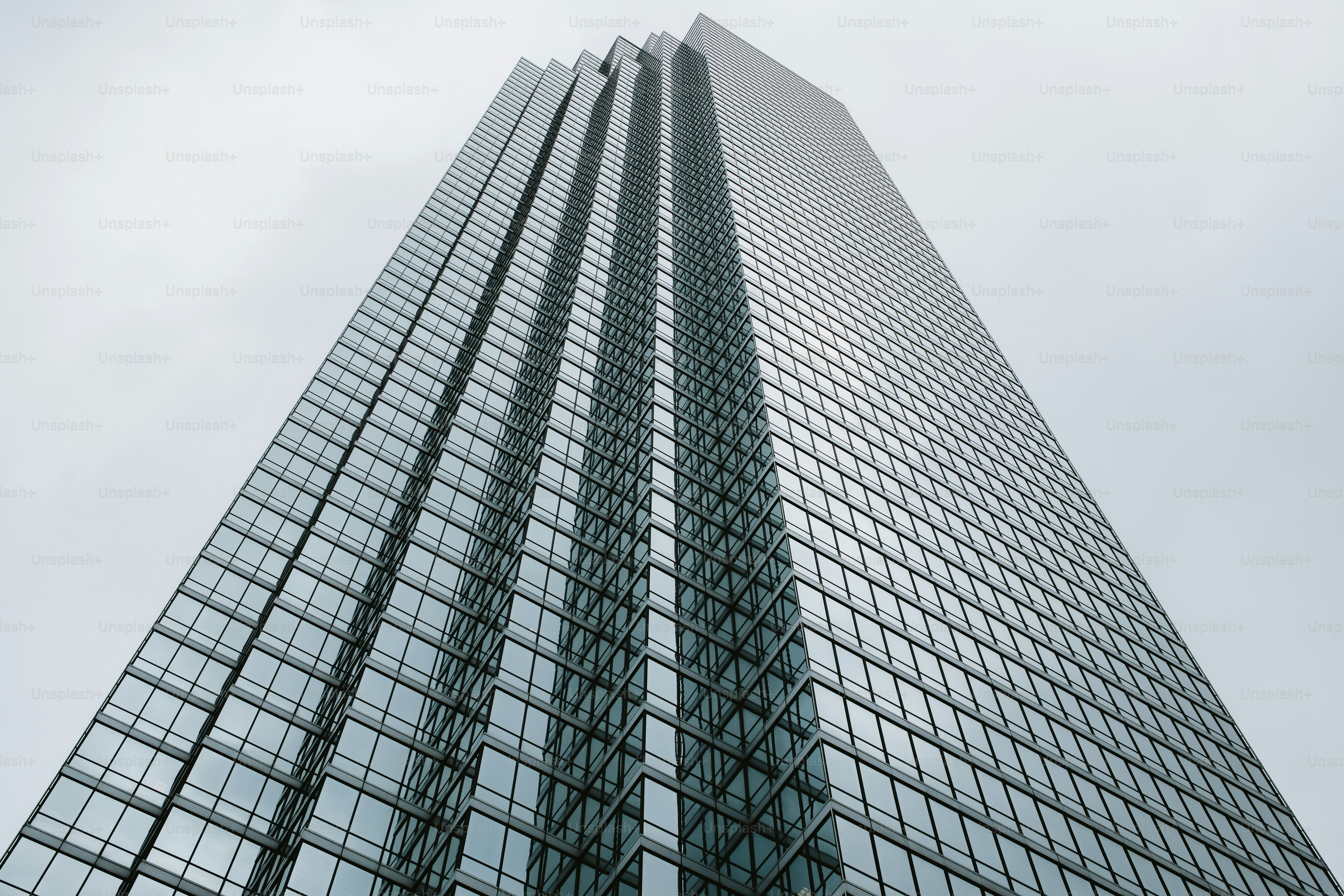 A tall glass skyscraper reaches for the sky. photo – Architecture Image ...