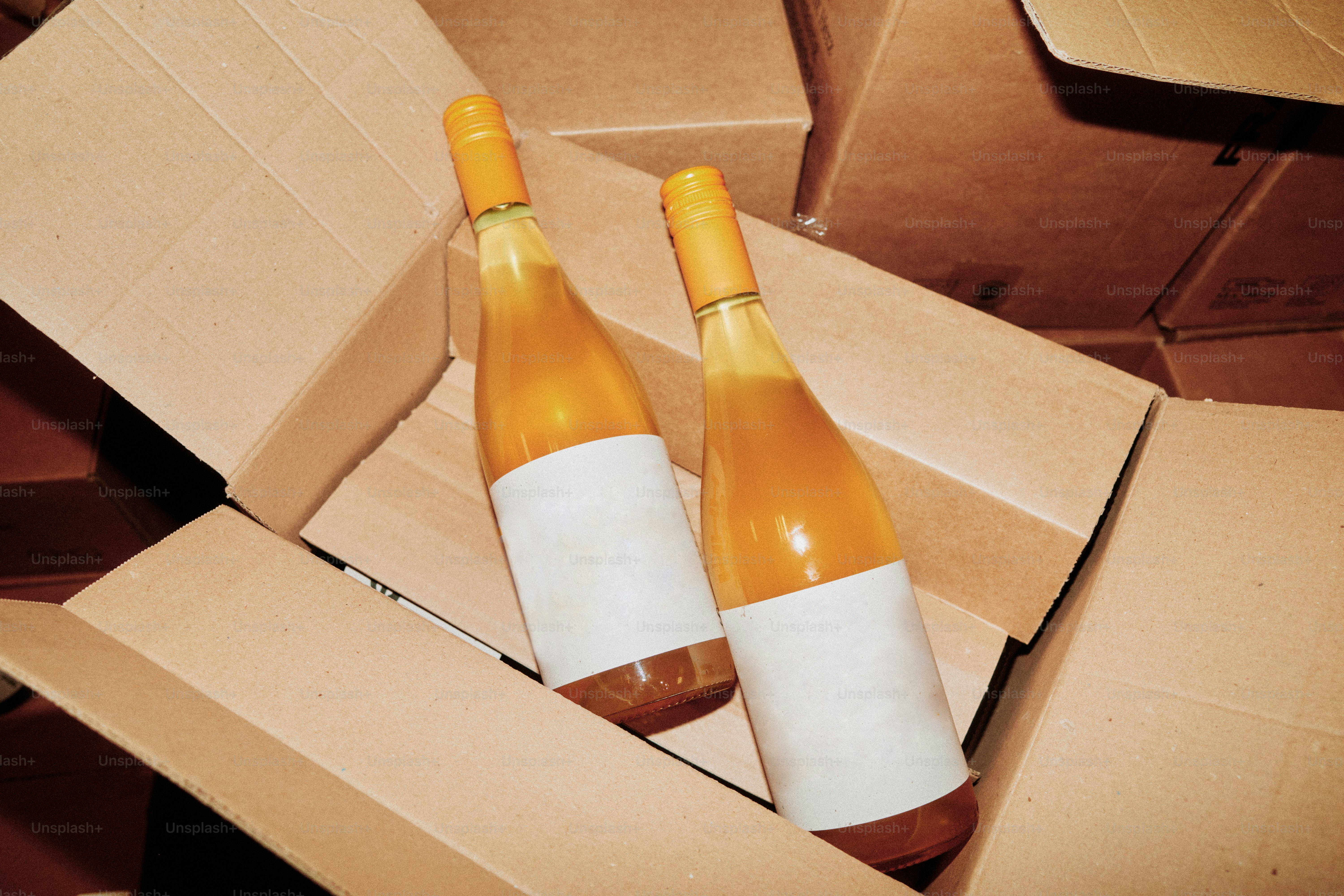 Two bottles of wine sit in an open box. photo – Natural Image on Unsplash