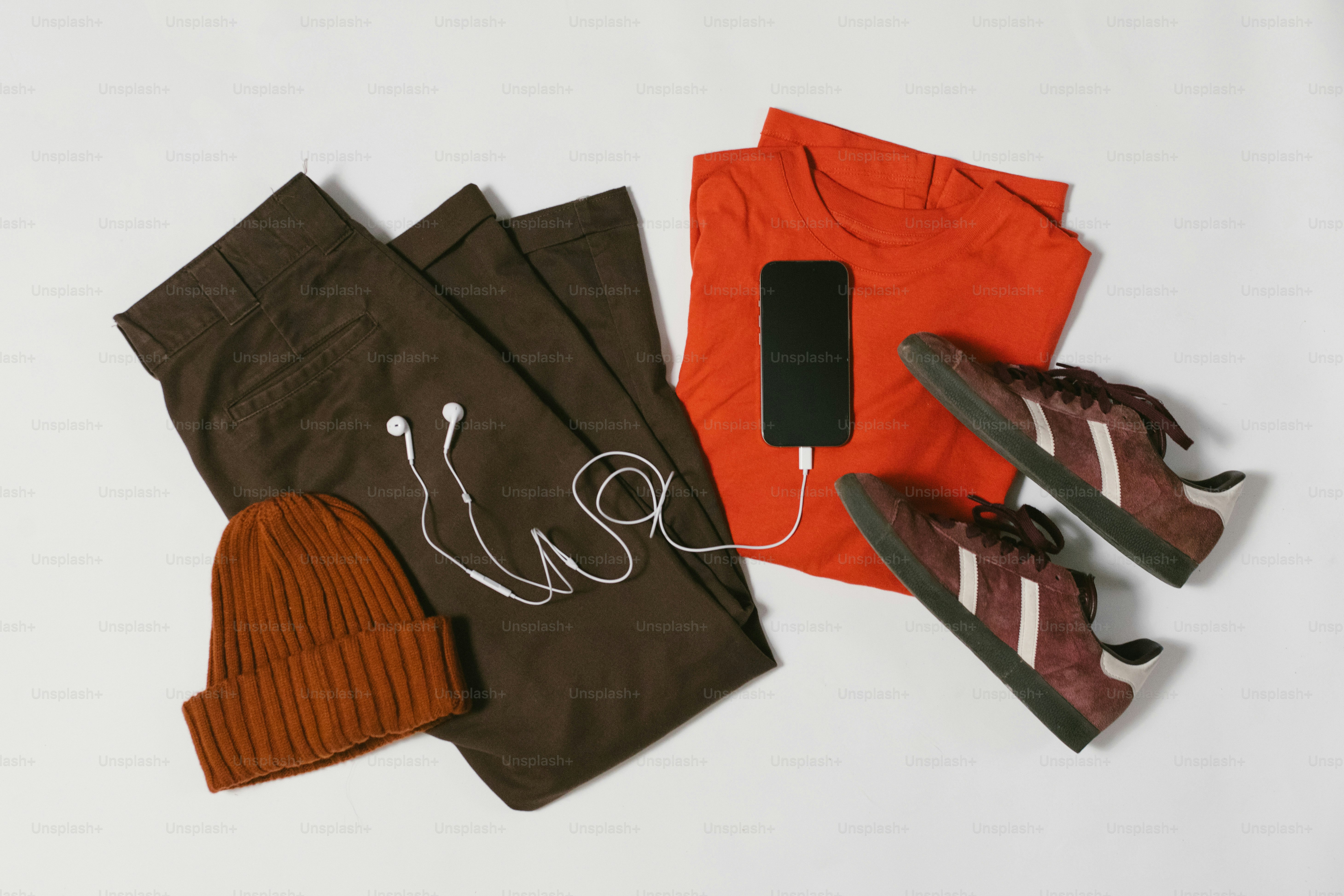 Casual clothing, accessories, and a smartphone laid out. photo ...