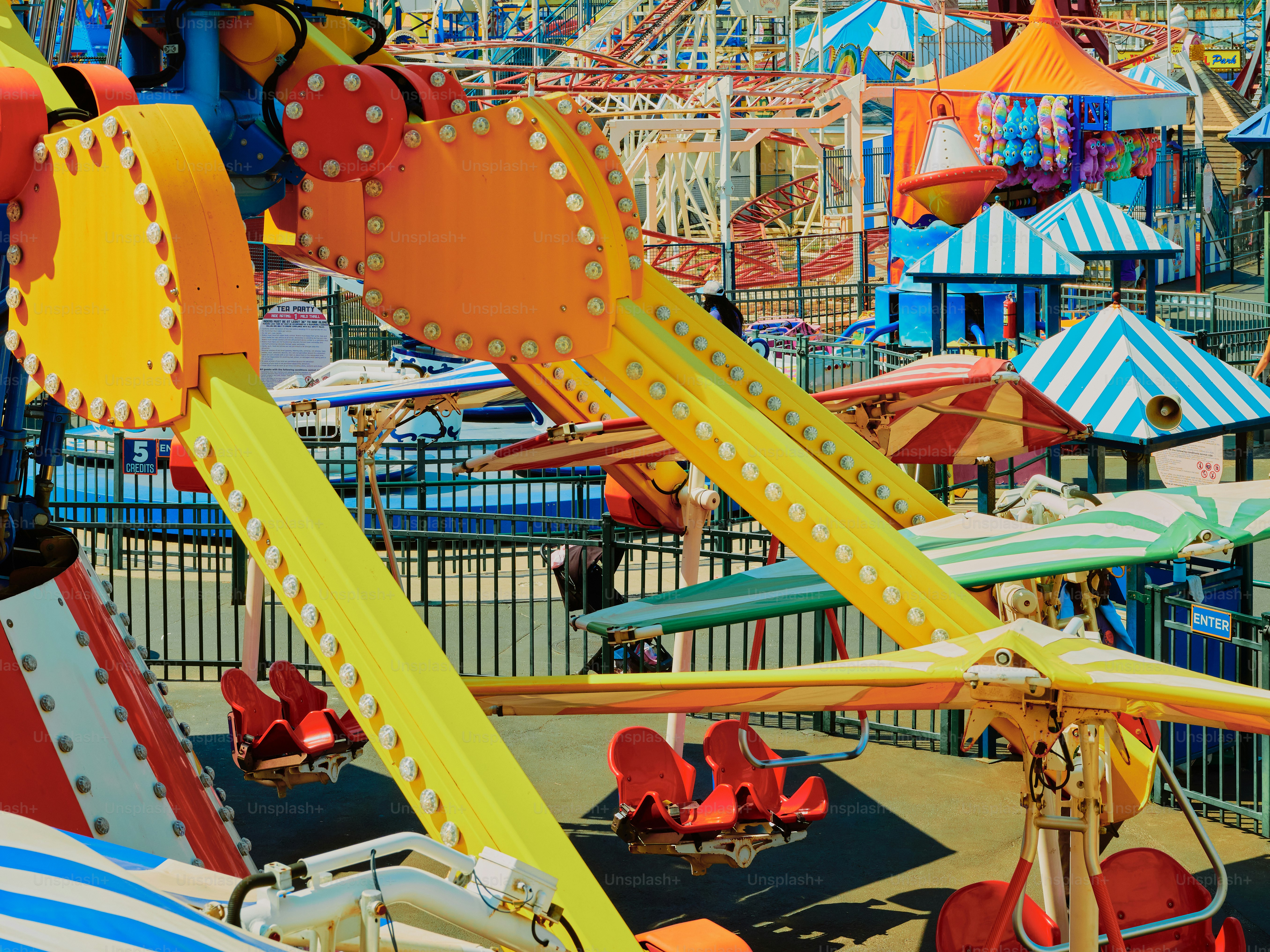 An amusement park with colorful rides. photo – Film photography Image ...