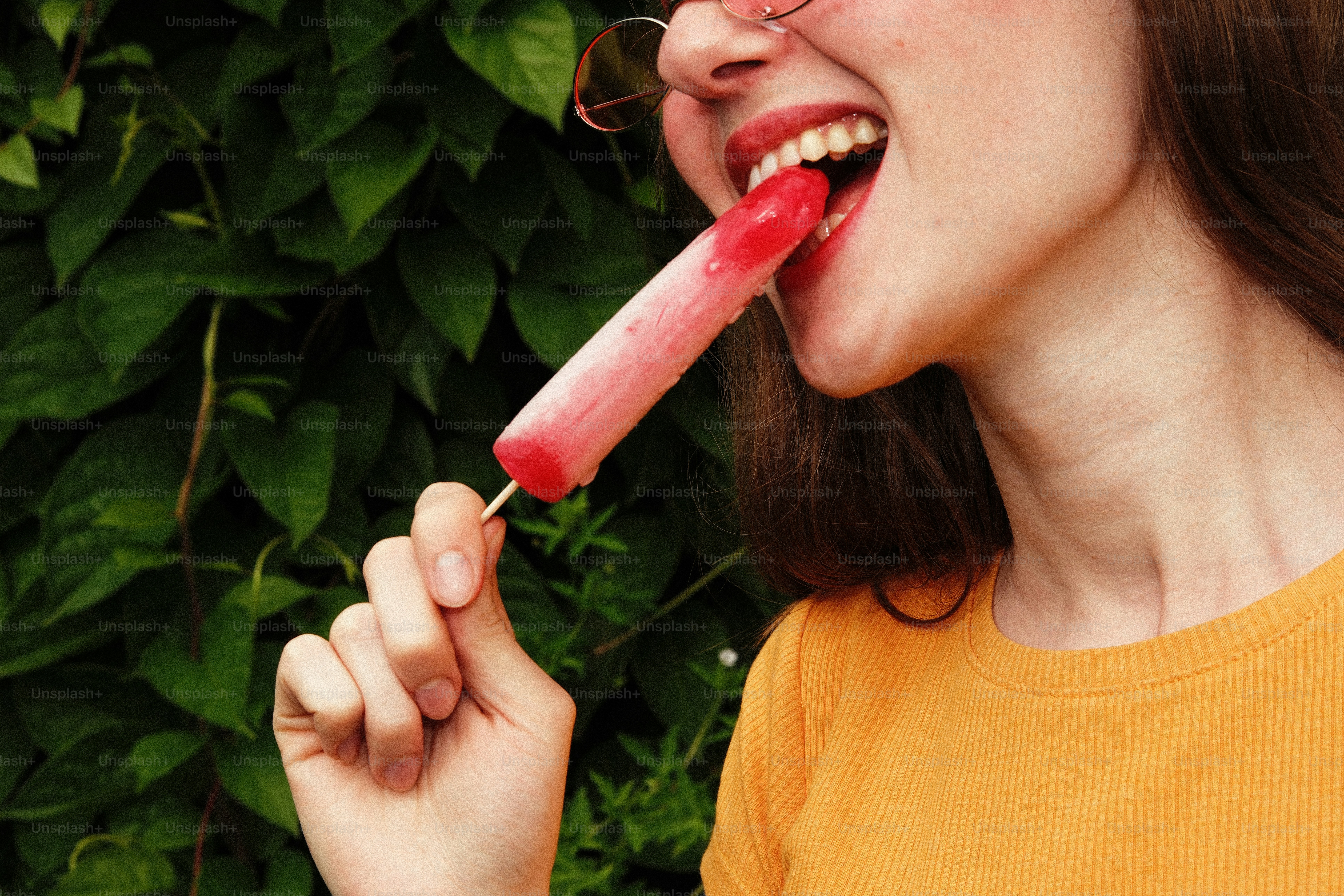 Woman enjoying a popsicle on a warm day. photo – Woman Image on Unsplash