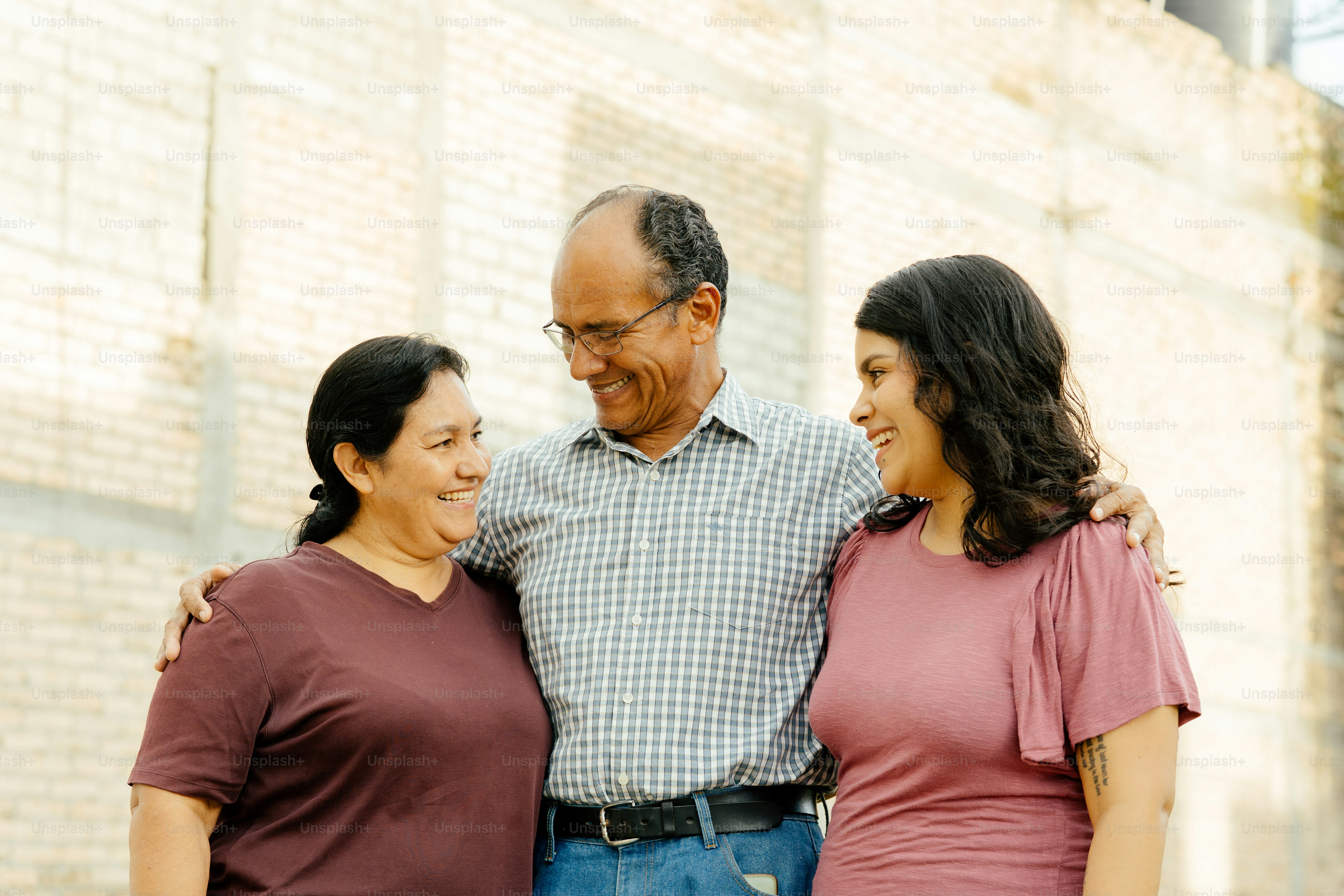 Three people are hugging and smiling at each other. photo – Family ...