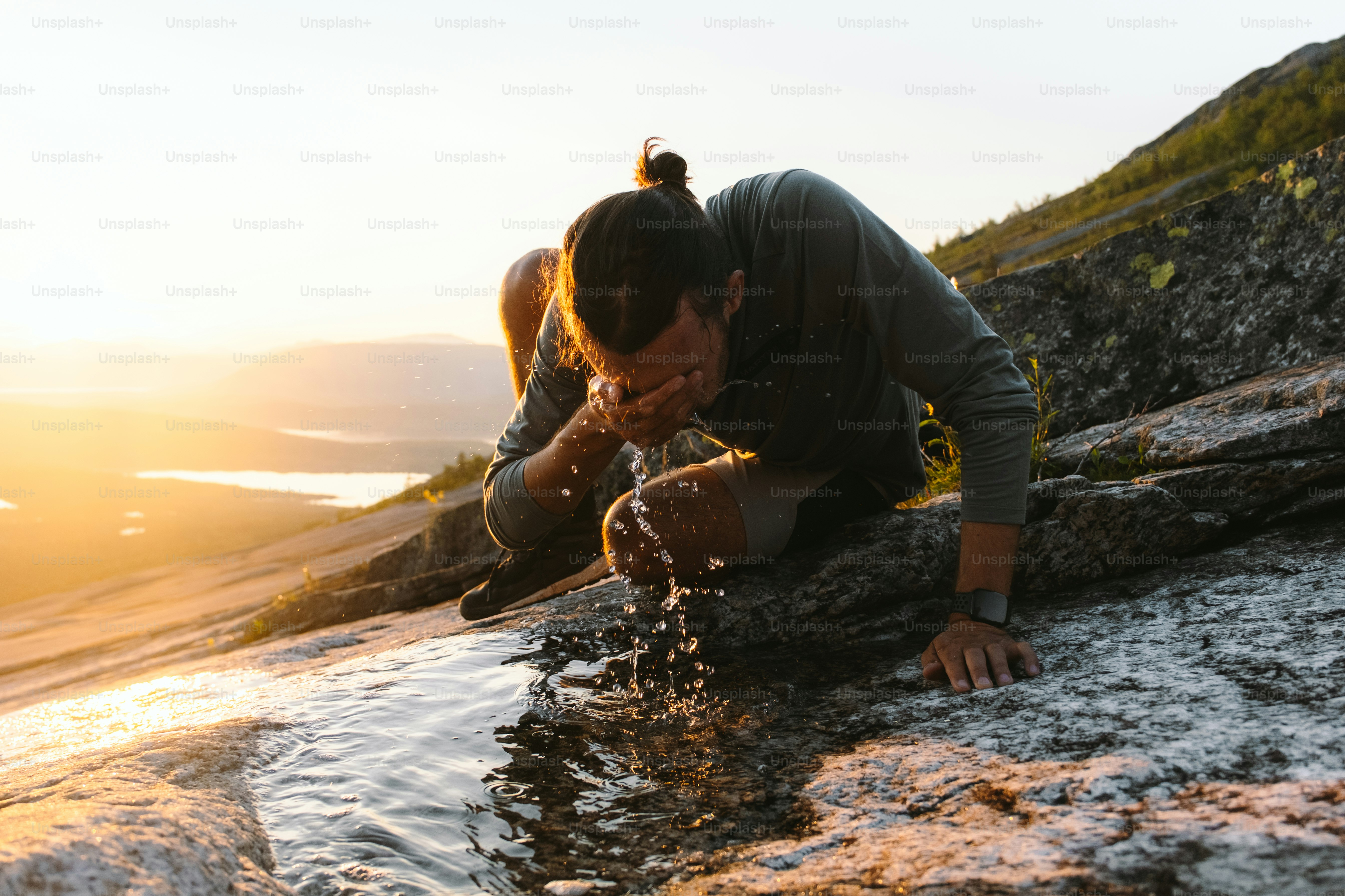 A man is drinking water from a mountain stream. photo – Travel Image on ...