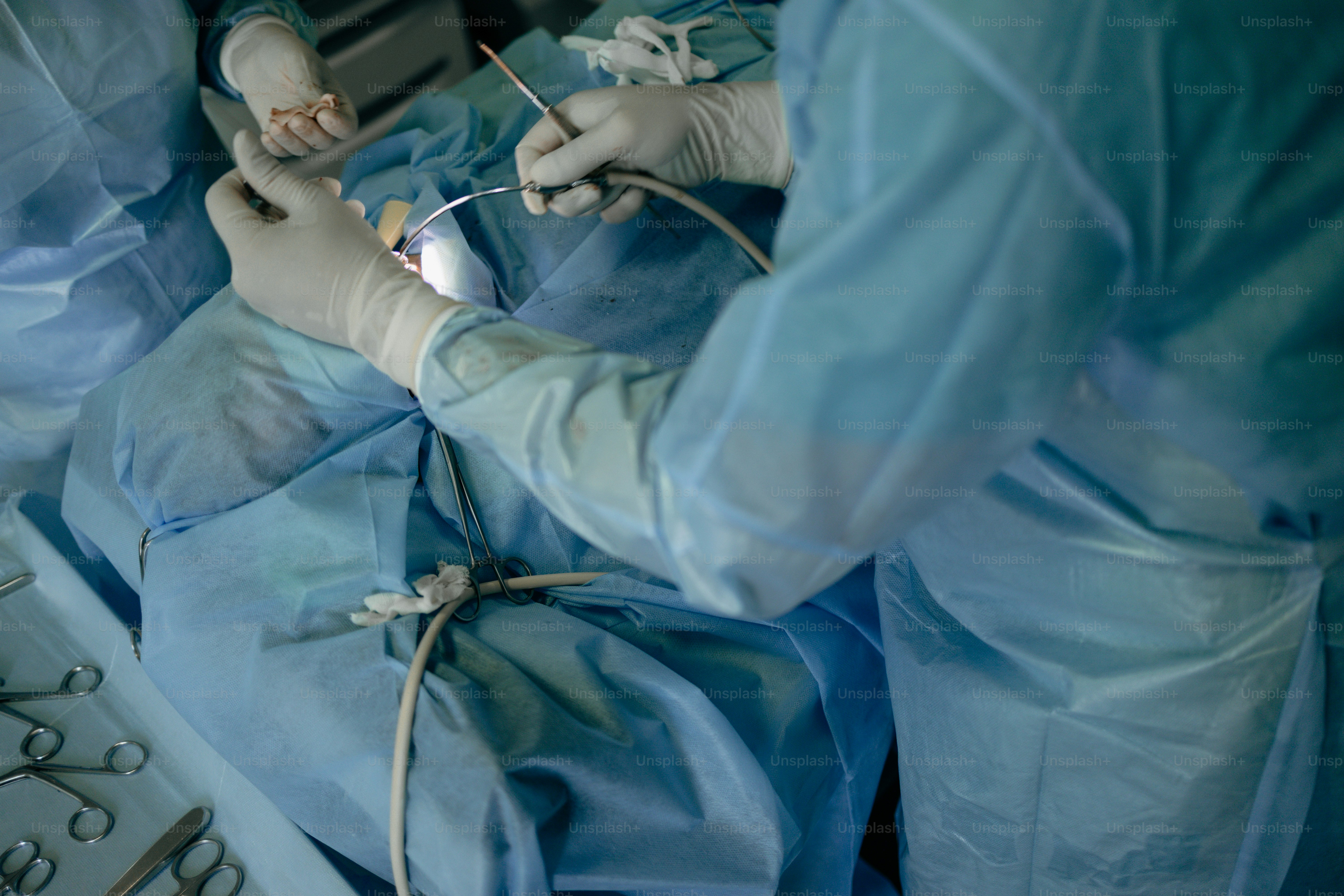 Surgeons are performing an operation in an operating room. photo ...