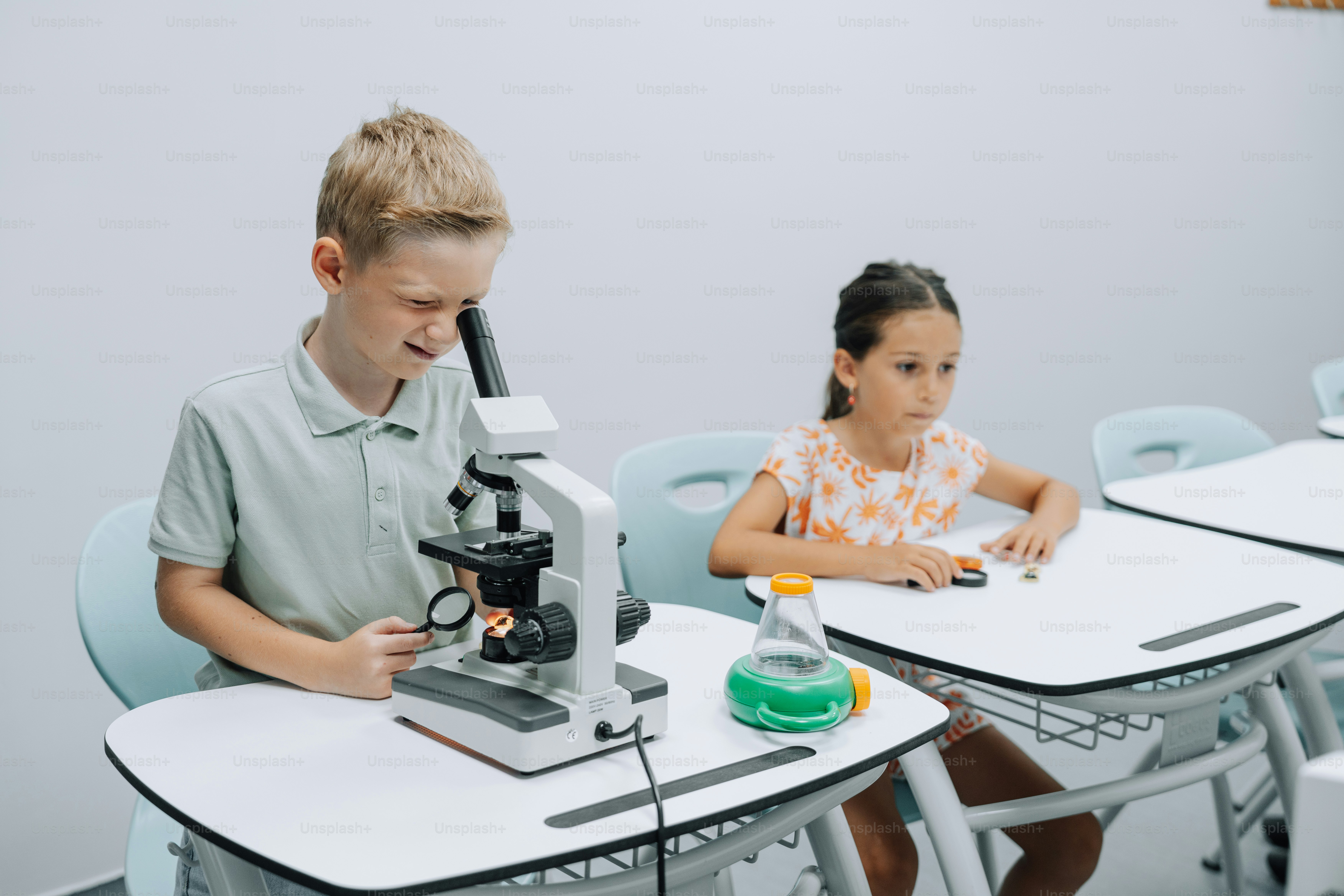 Students are doing a science experiment at their desks. photo ...
