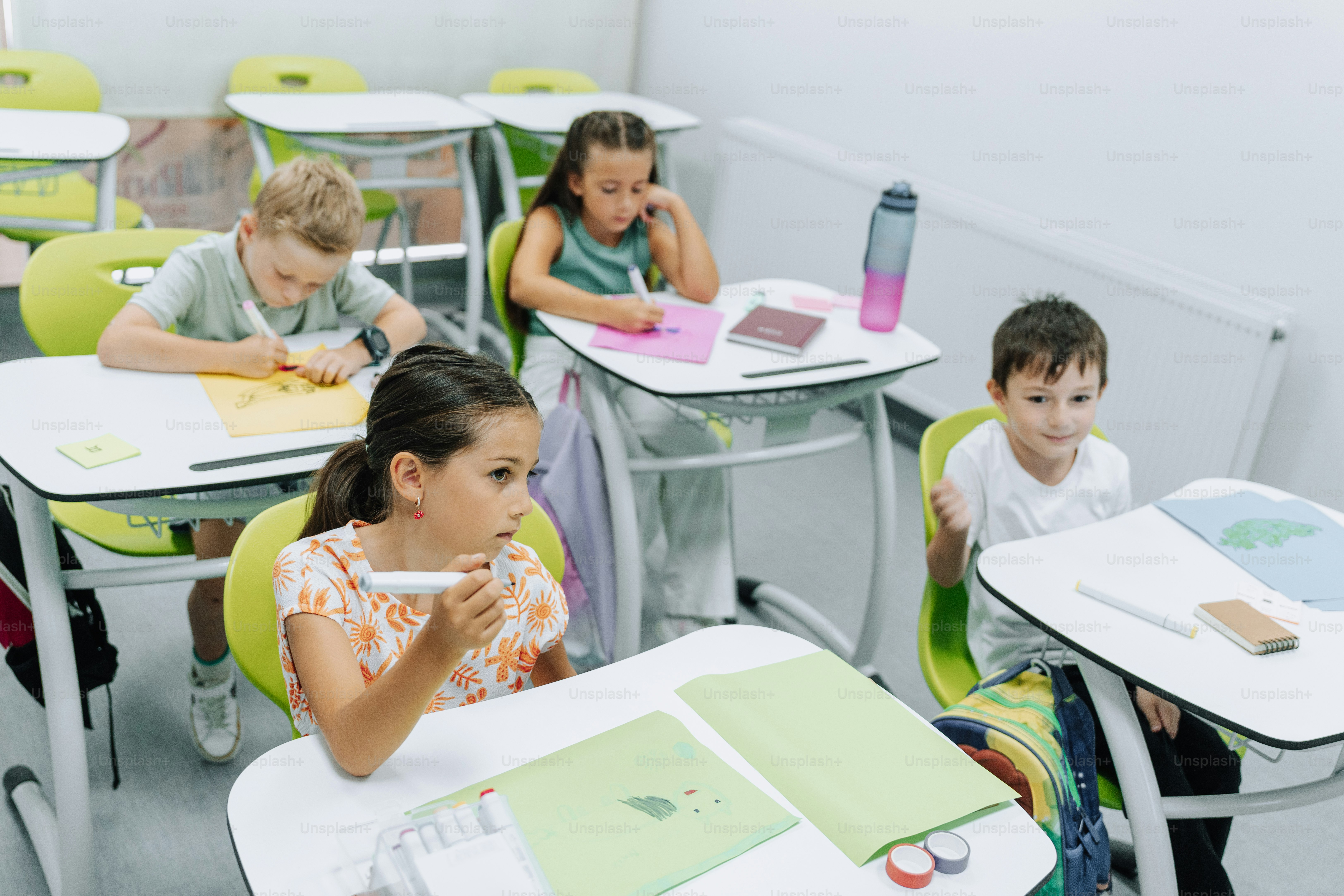 Students are working at desks in a classroom. photo – Education Image ...