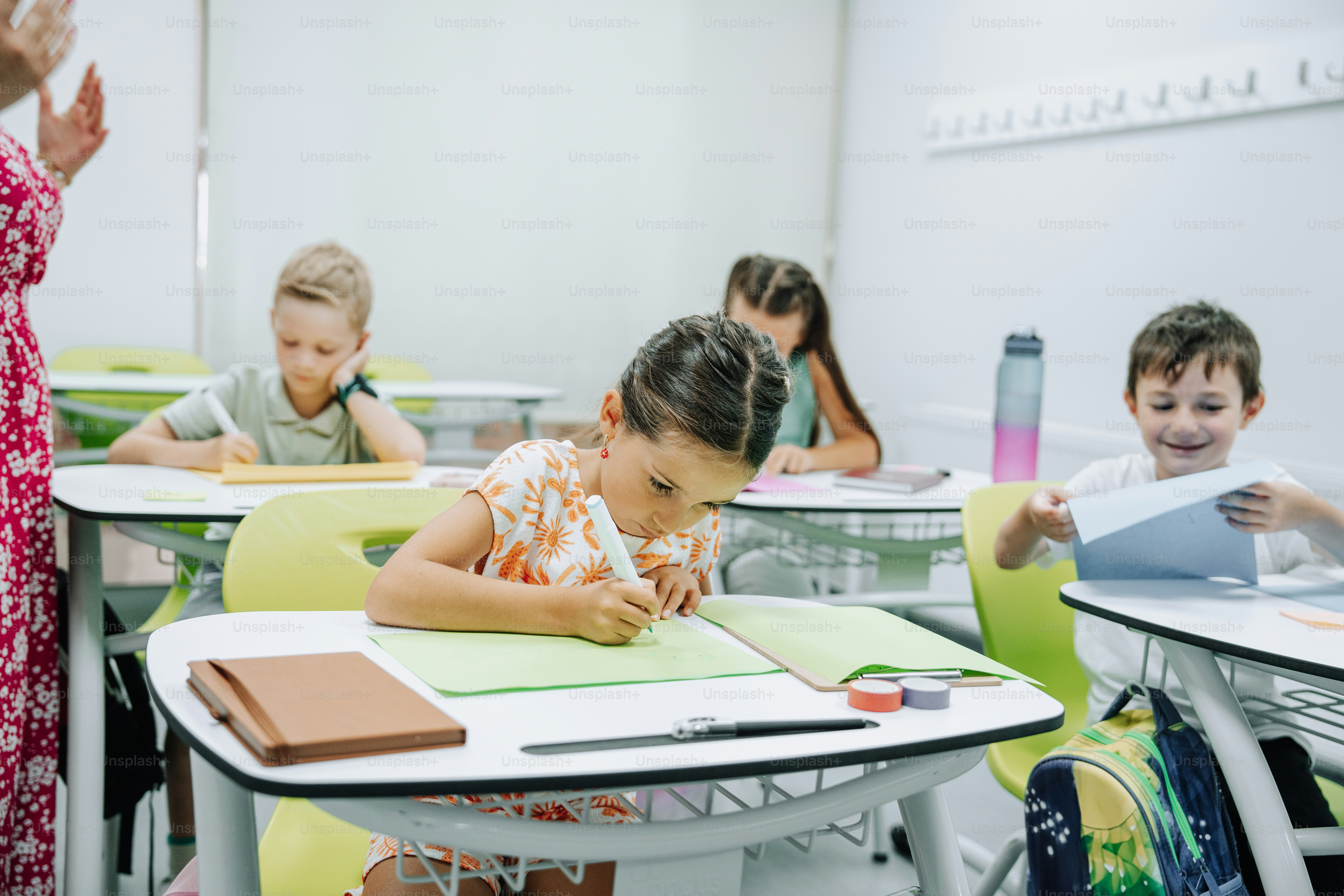 Students are working at desks in a classroom. photo – Education Image ...