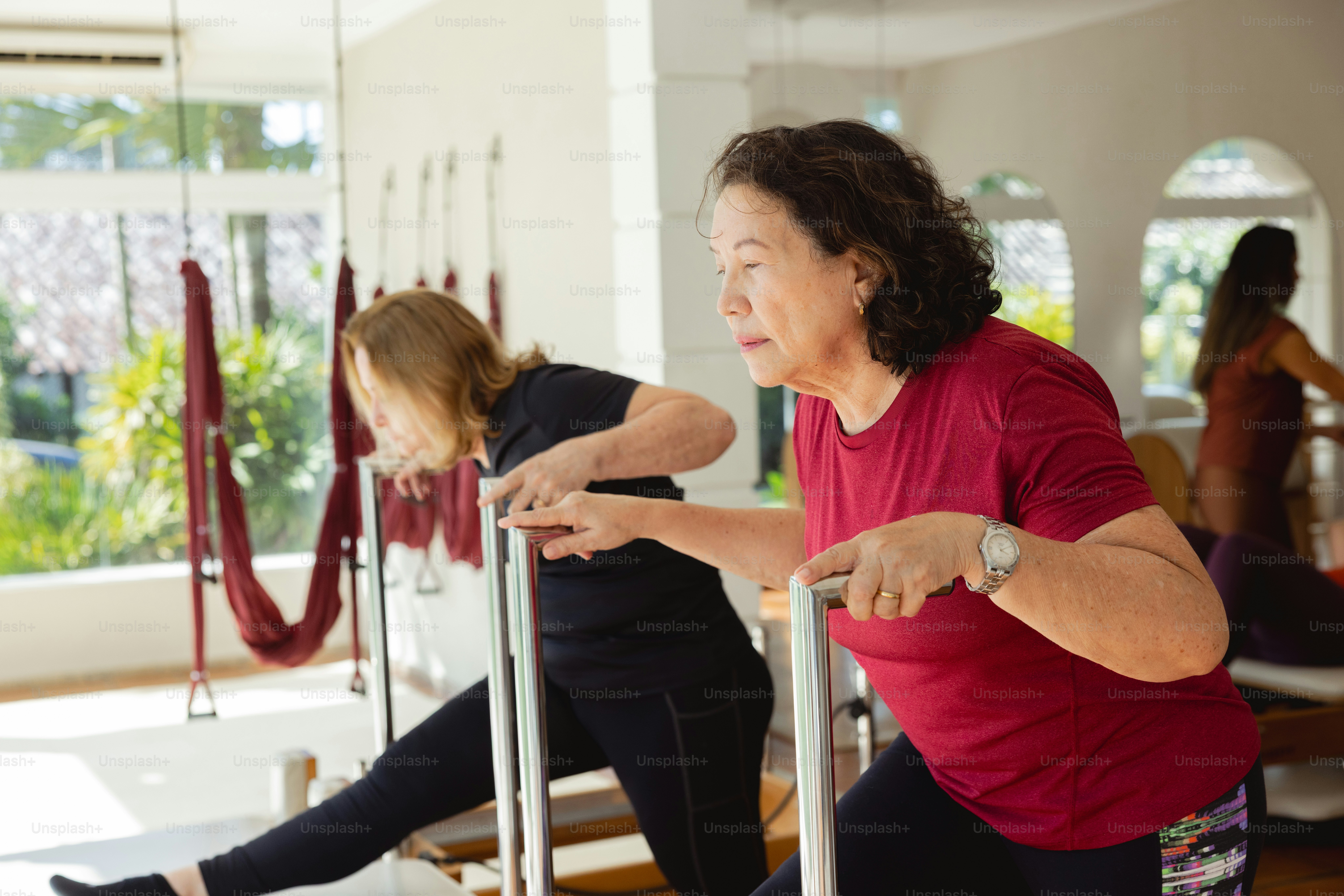 Older women exercise in a bright, airy studio. photo – Exercise Image ...