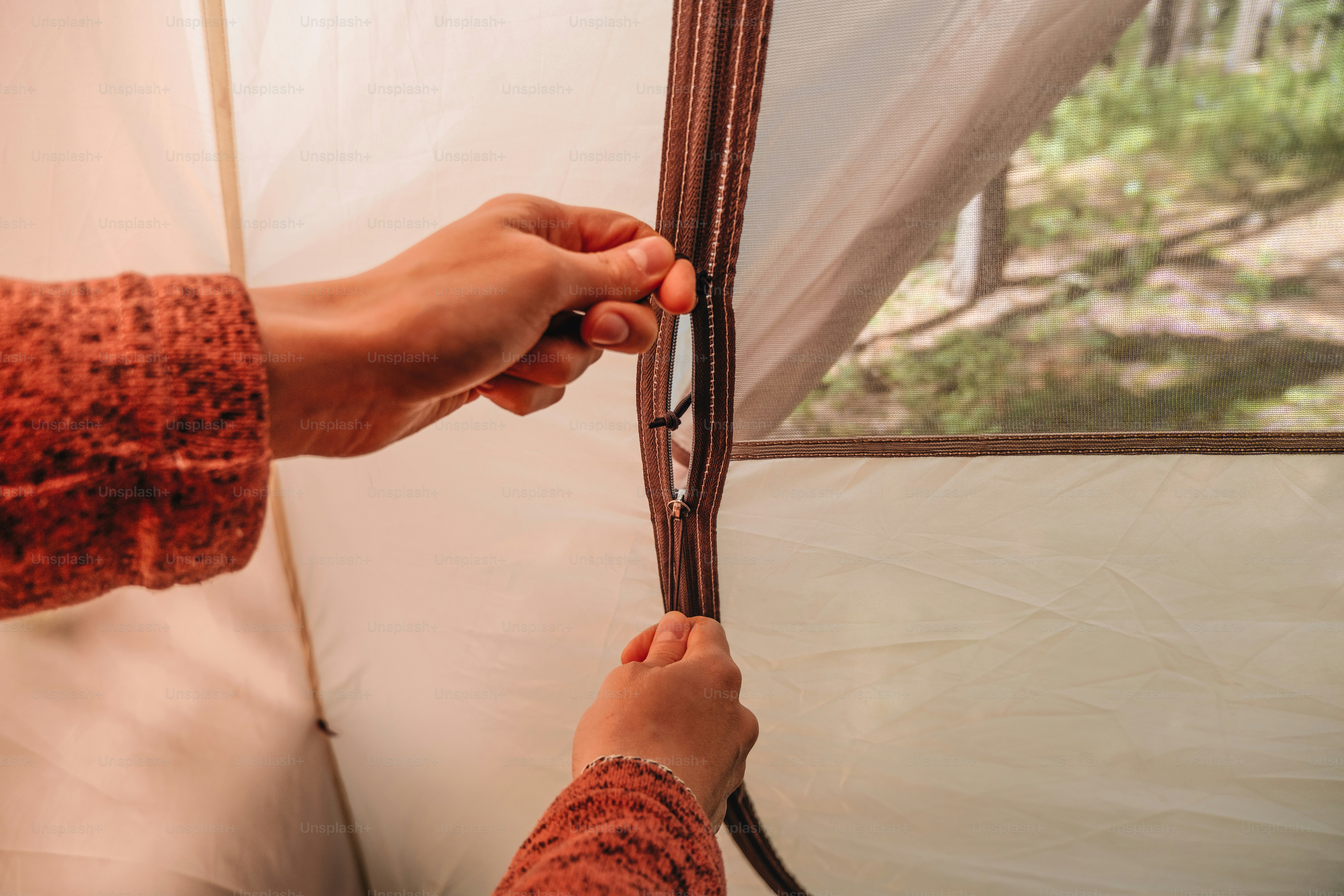 Opening a tent zipper from the inside. photo – Travel Image on Unsplash