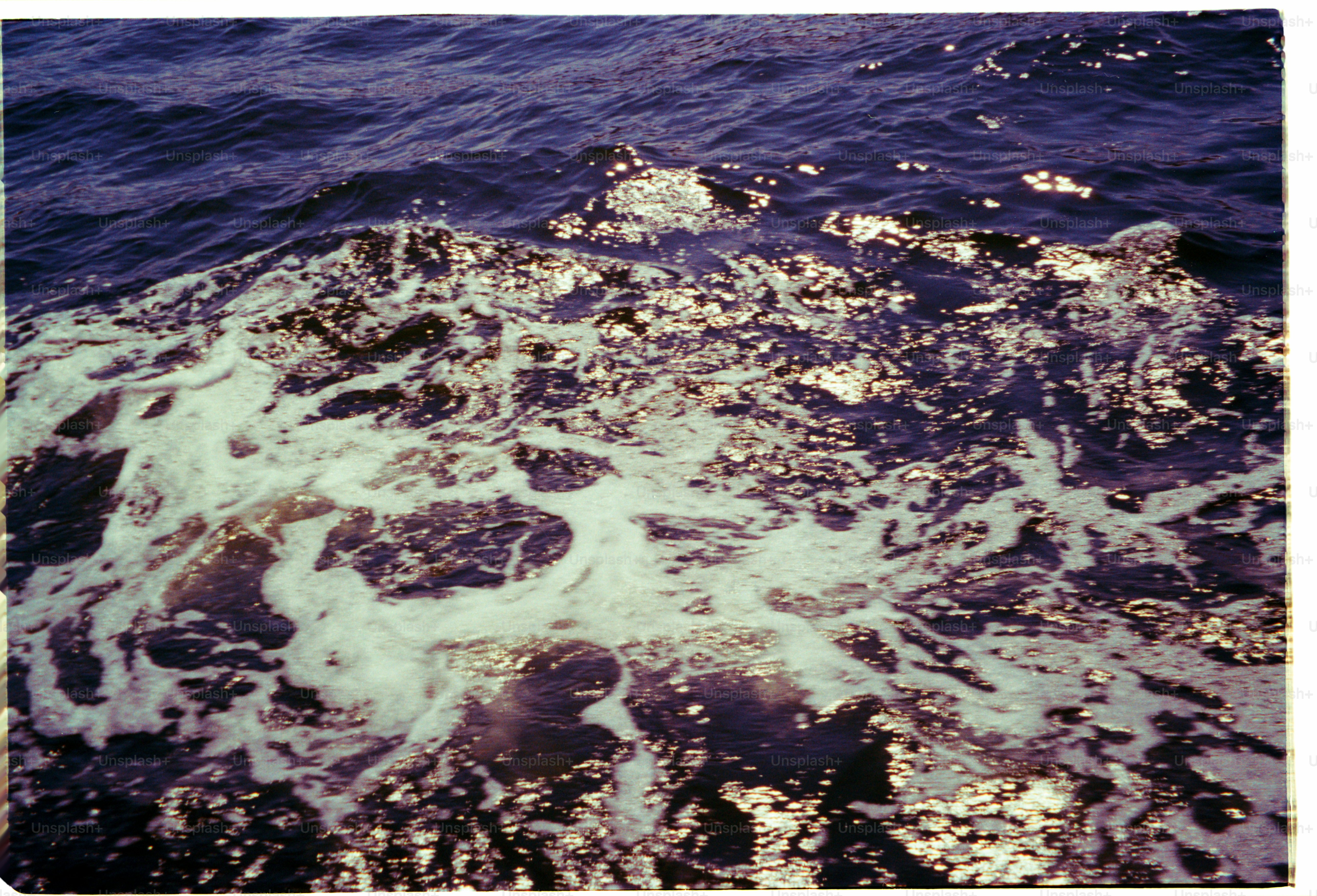 Waves churn and foam atop dark ocean water. photo – Sweden Image on ...