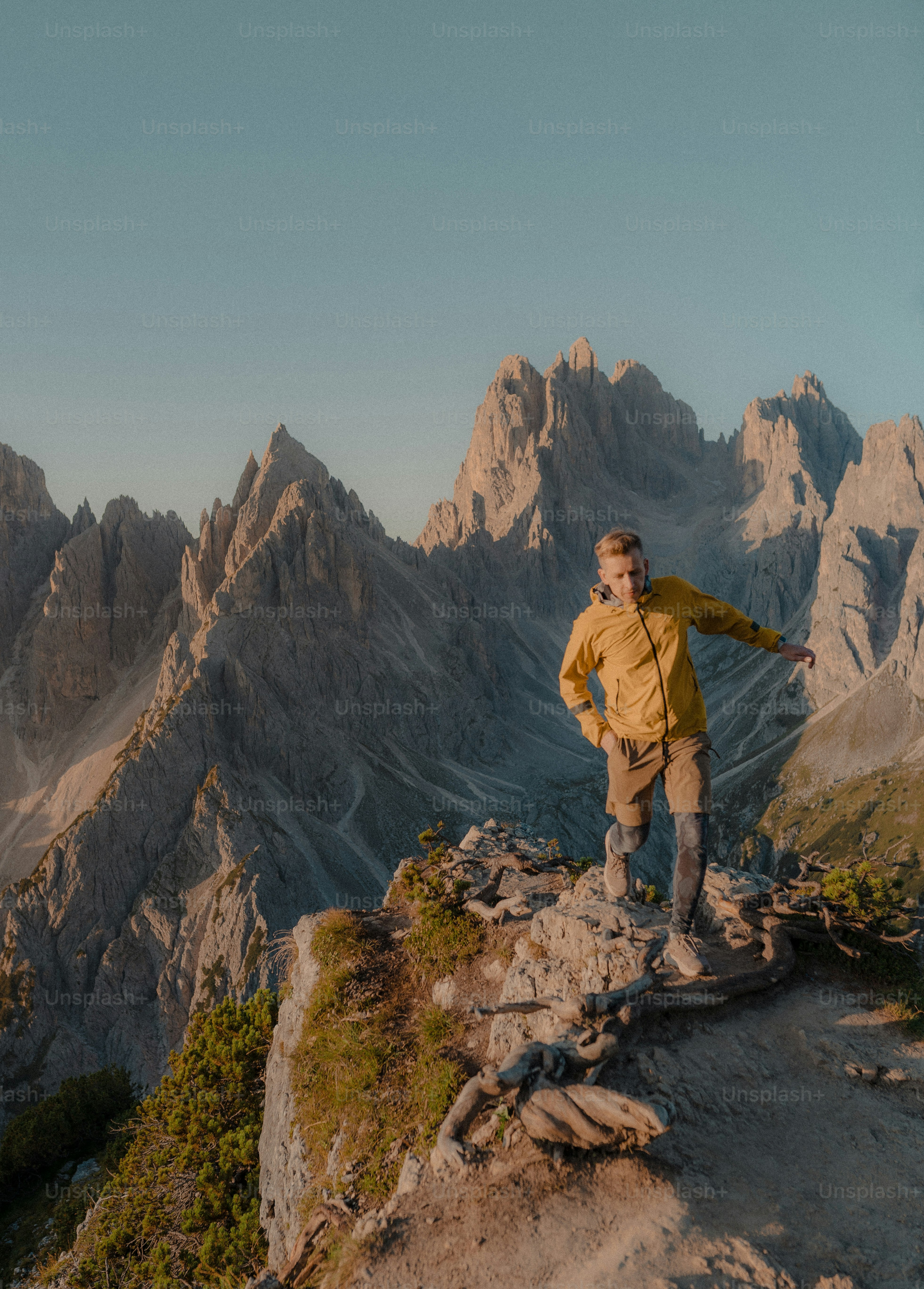 Hiker poses on a mountain ridge with scenic peaks. photo – Travel Image ...