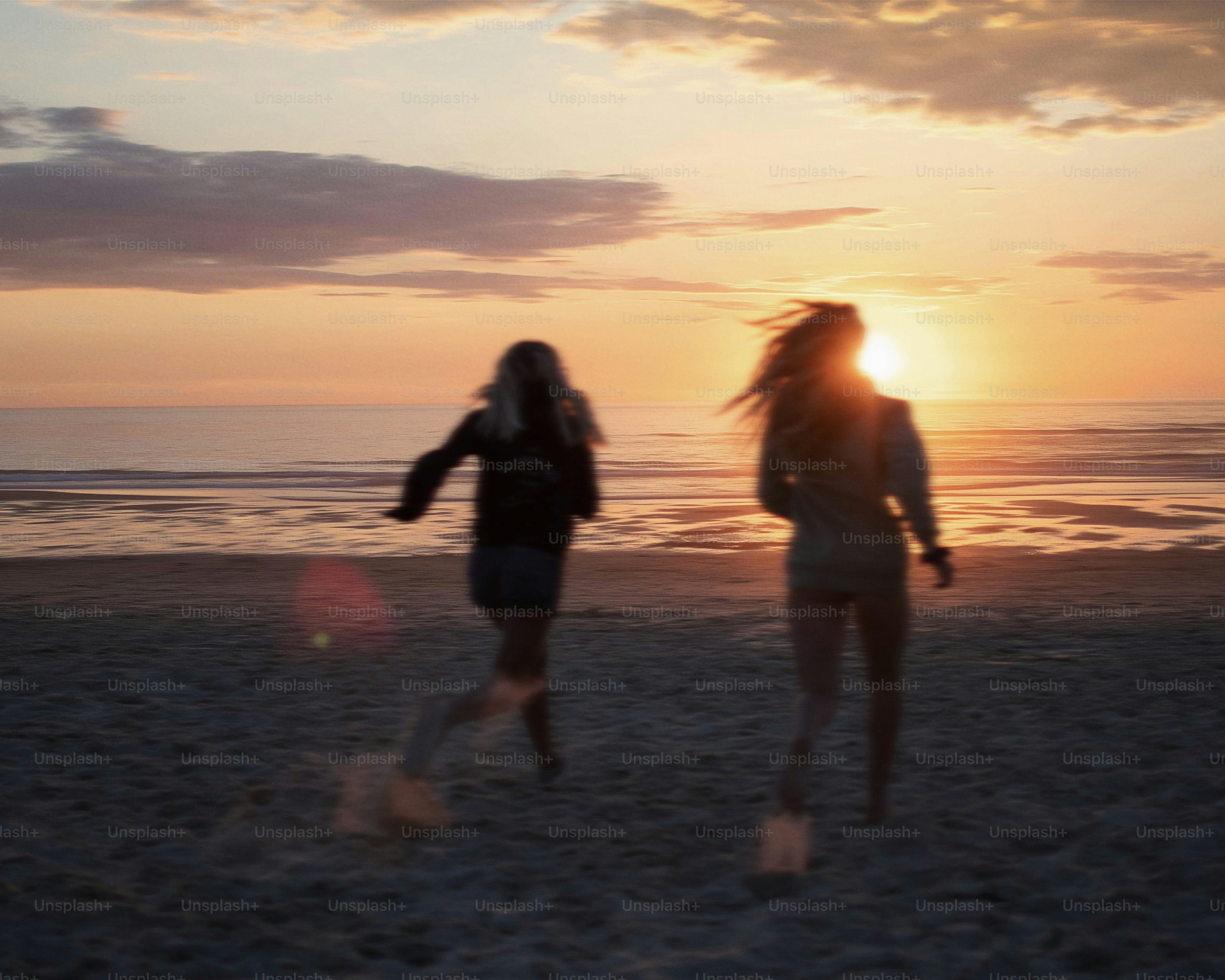 Friends run towards the ocean during a sunset. photo – Summer Image on ...