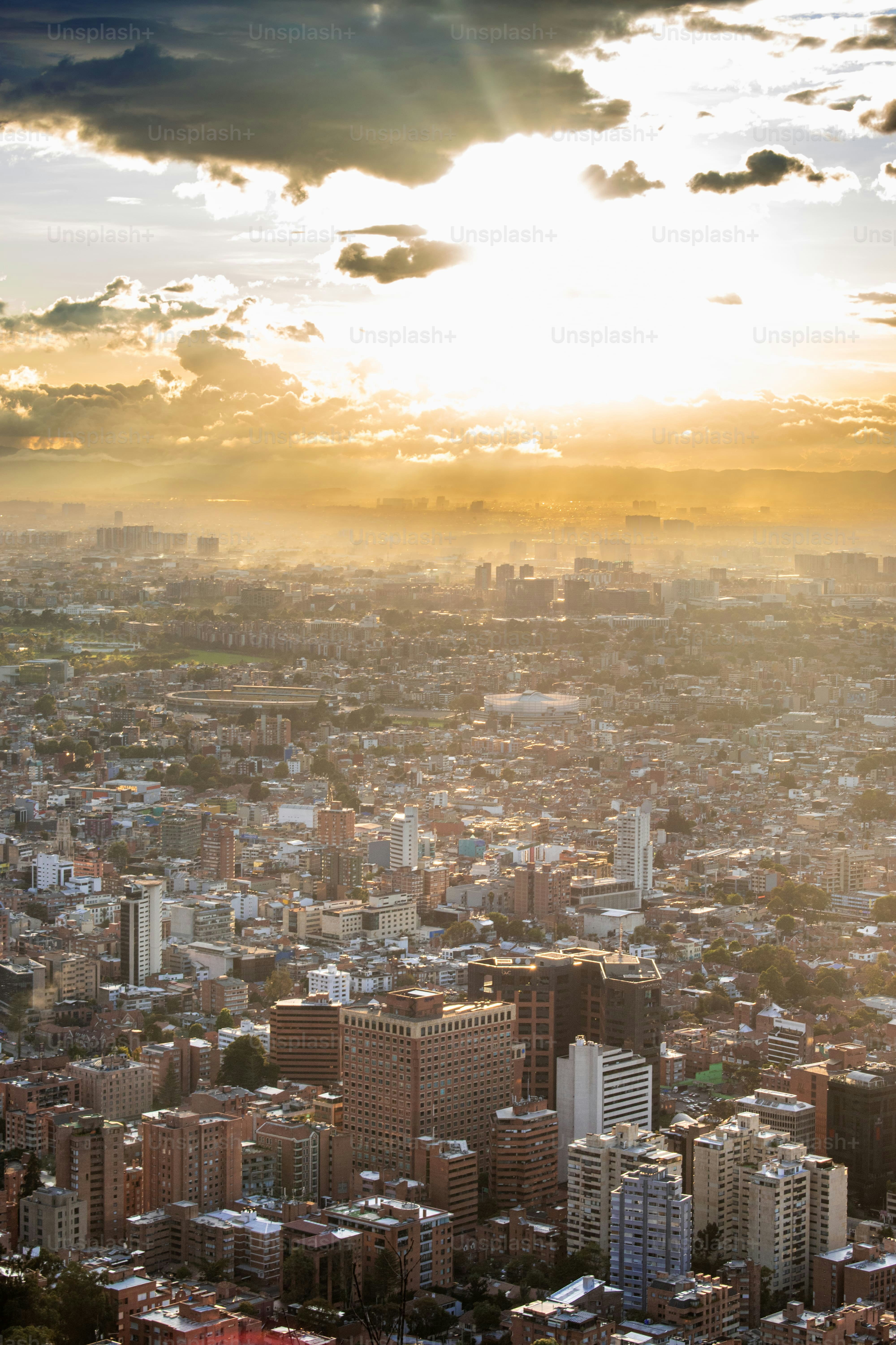 High angle view of Bogota city landscape at sunset photo – Sunset Image ...