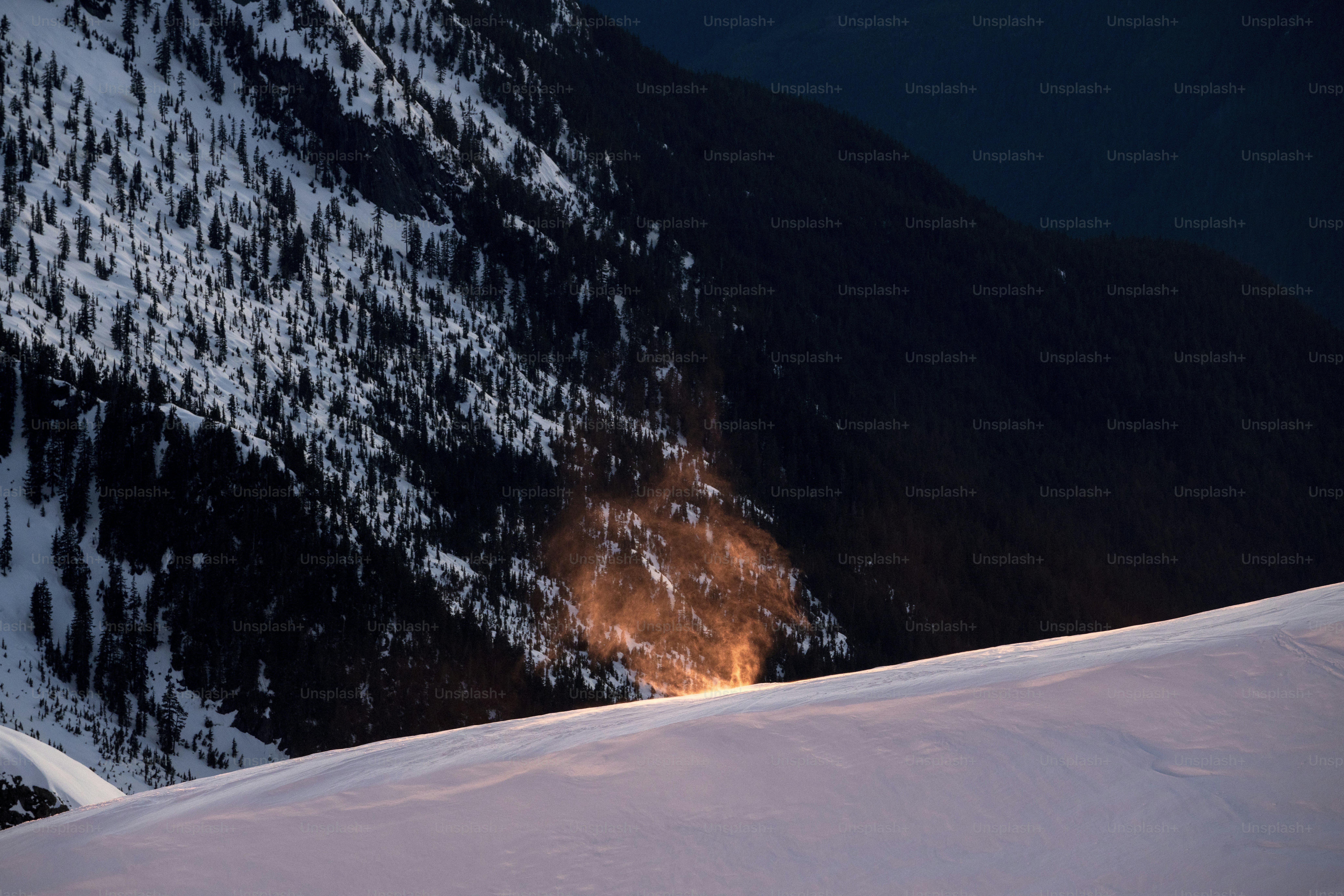 Alpine glow on mountain peak and headlamps from ski mountaineers ...