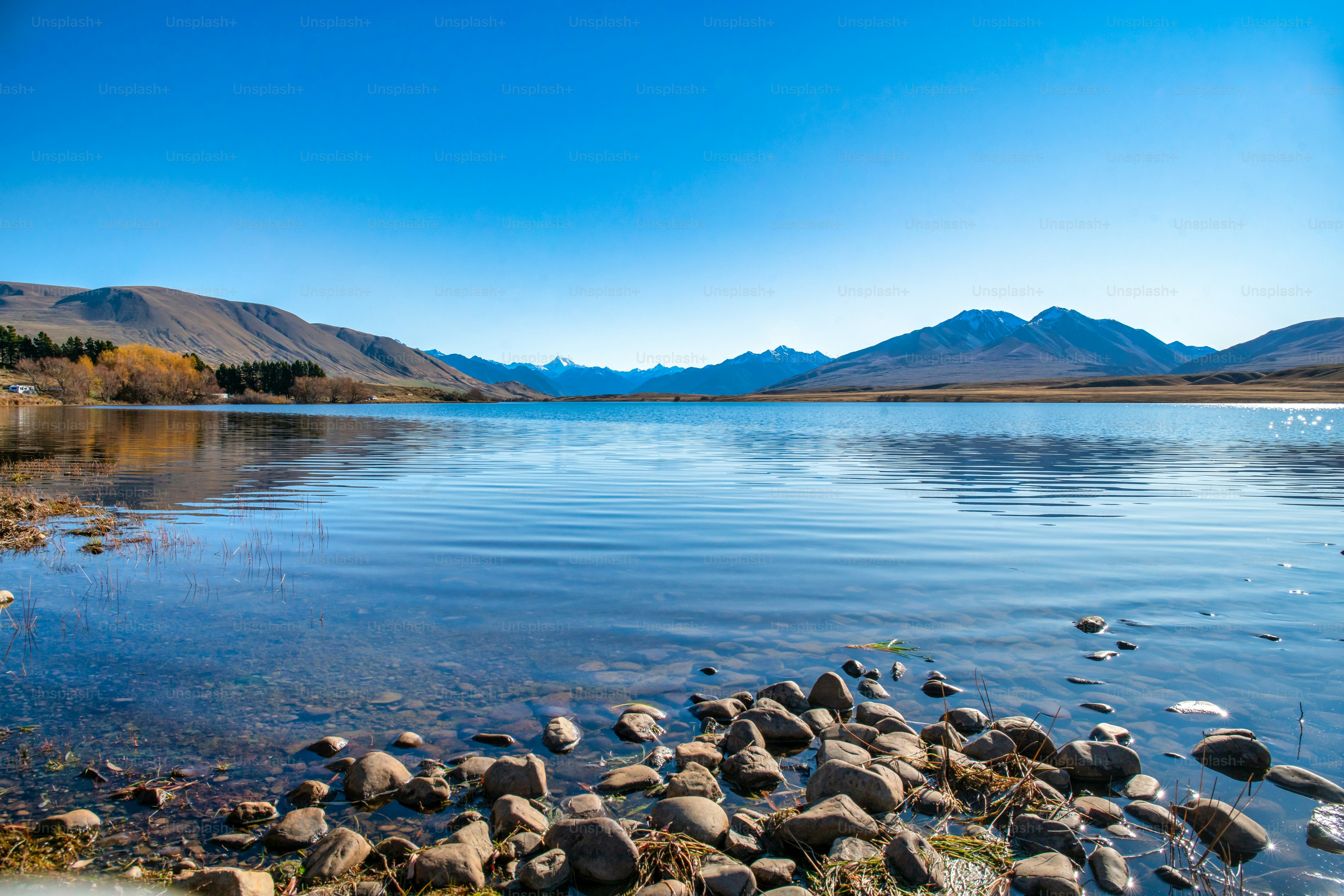 The arid extreme countryside around the shore of alpine Lakes in the ...