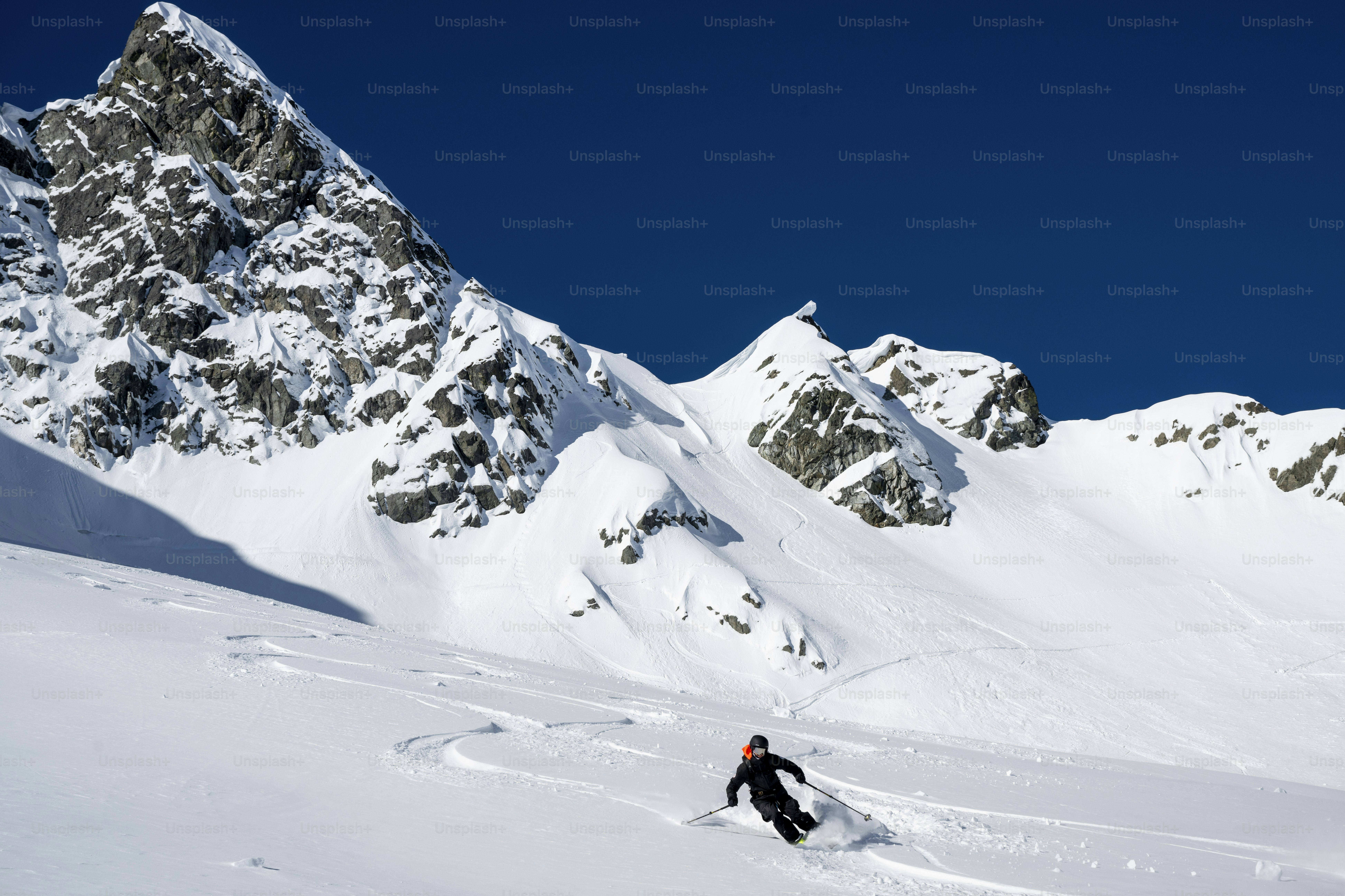 Ski mountaineer descends mountain slope at speed, Tantalus Ranges photo ...