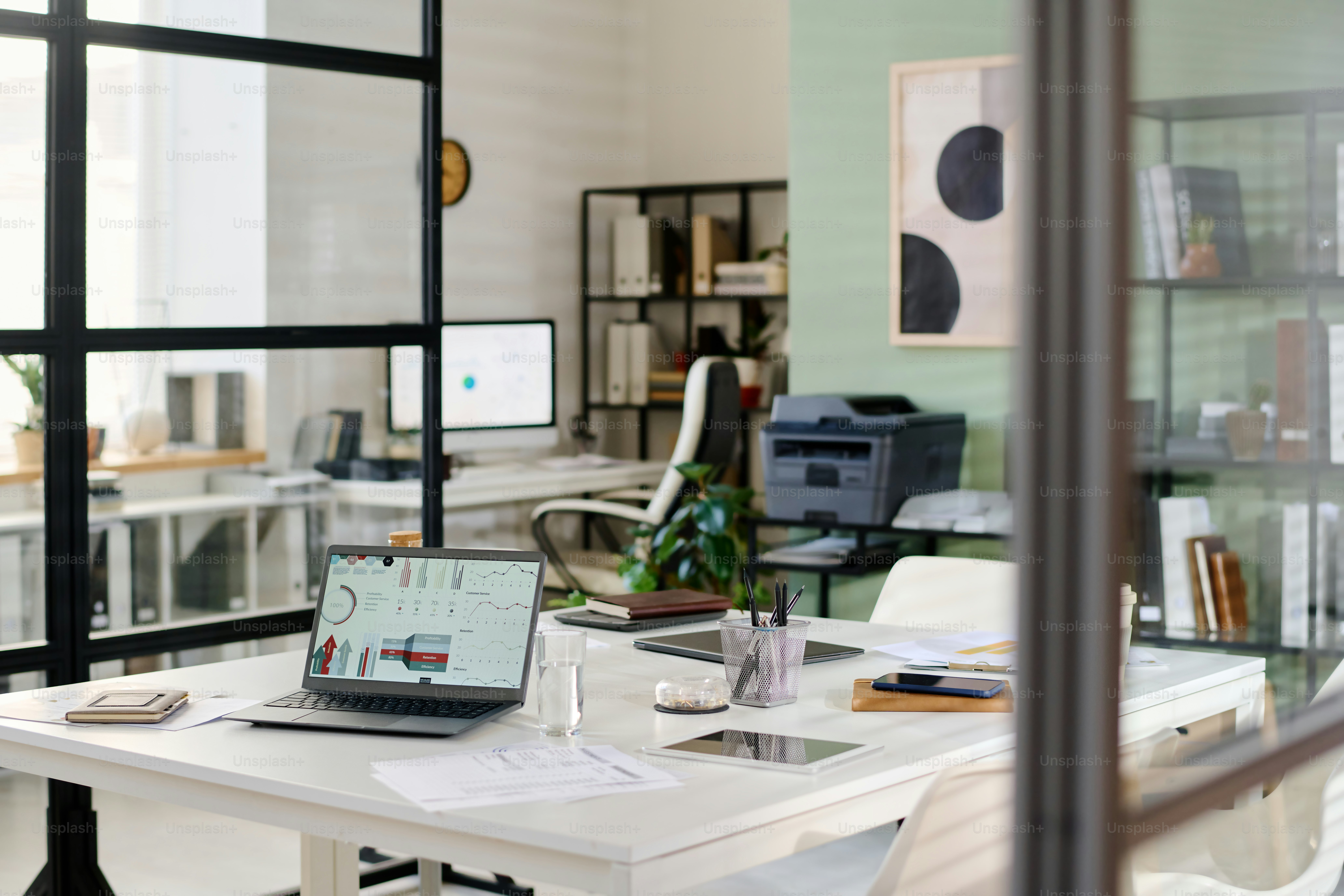Modern office interior featuring an open workspace with glass ...