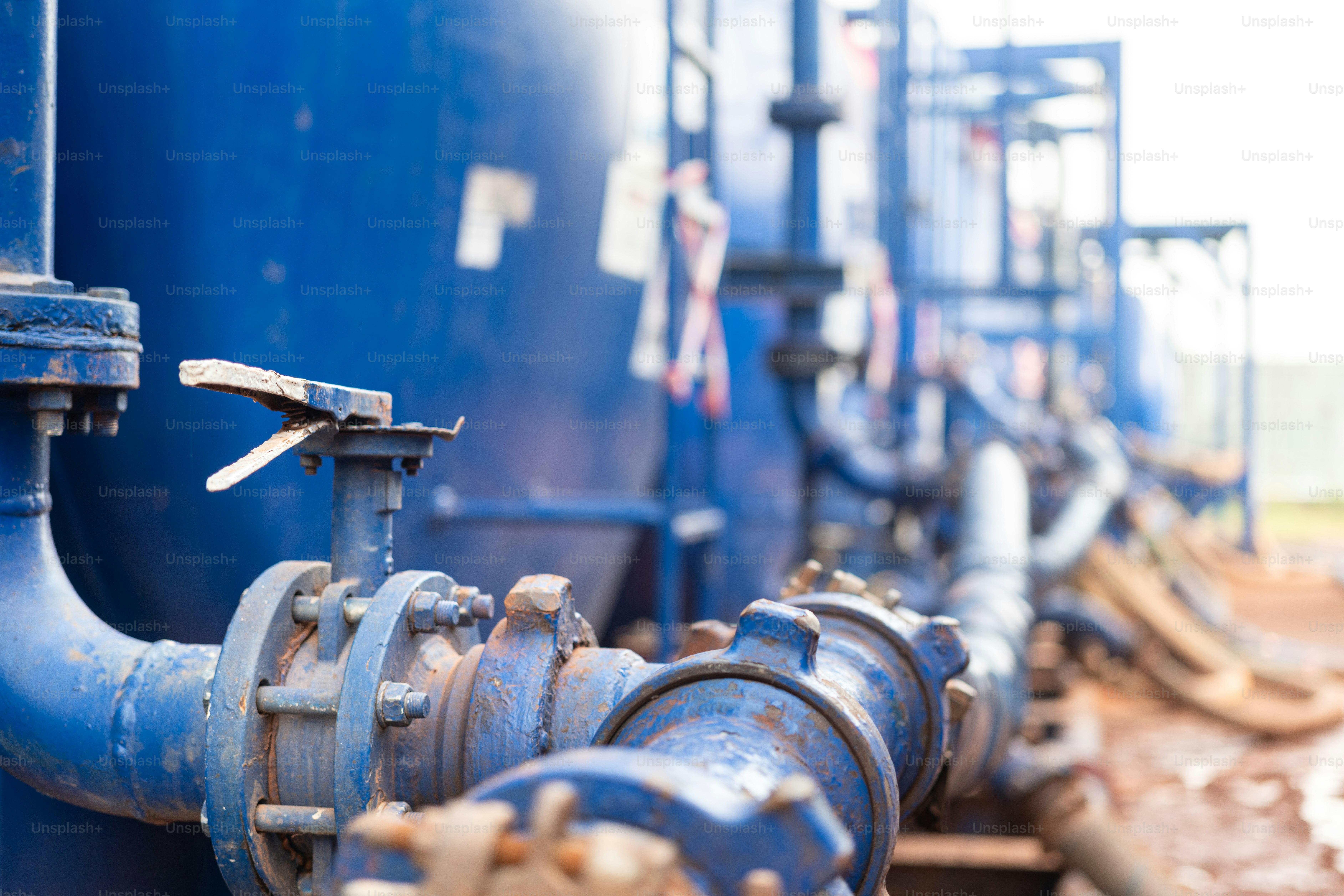 Close-up at valve of high-pressure rigid pipeline at the chemical ...