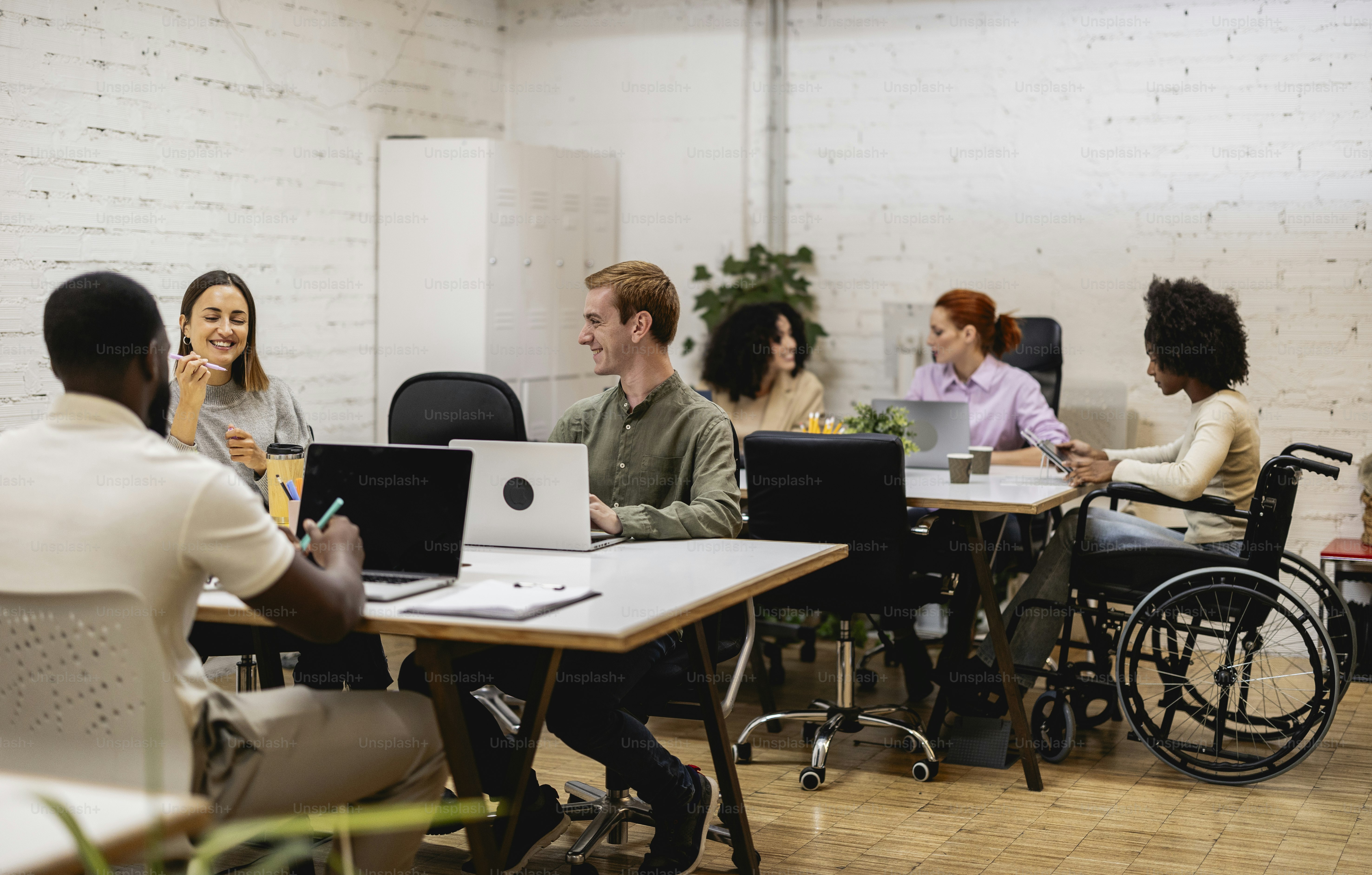 Multiracial team working together in a bright, modern office ...