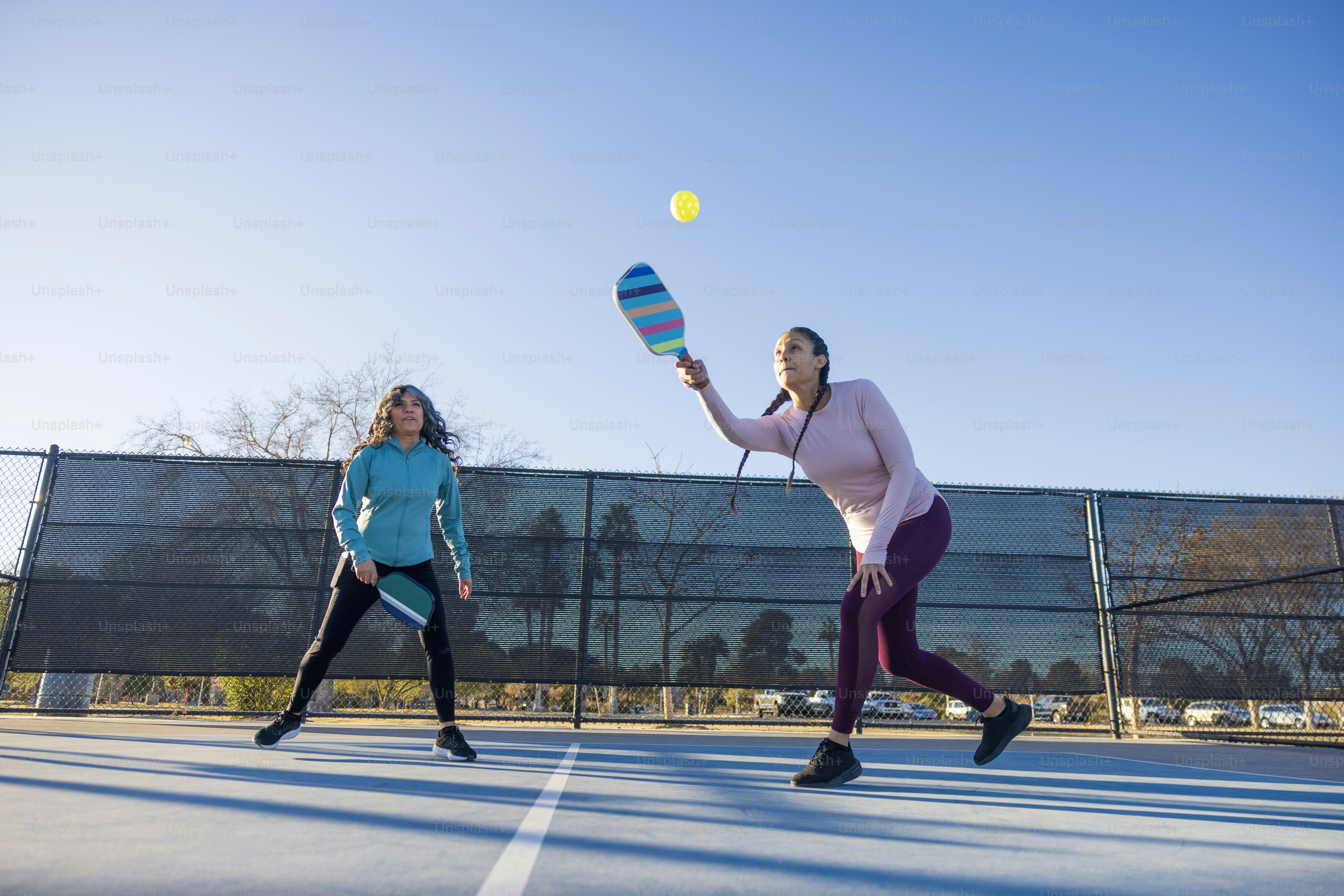 Women playing pickleball in the morning at the park. photo – Sport ...