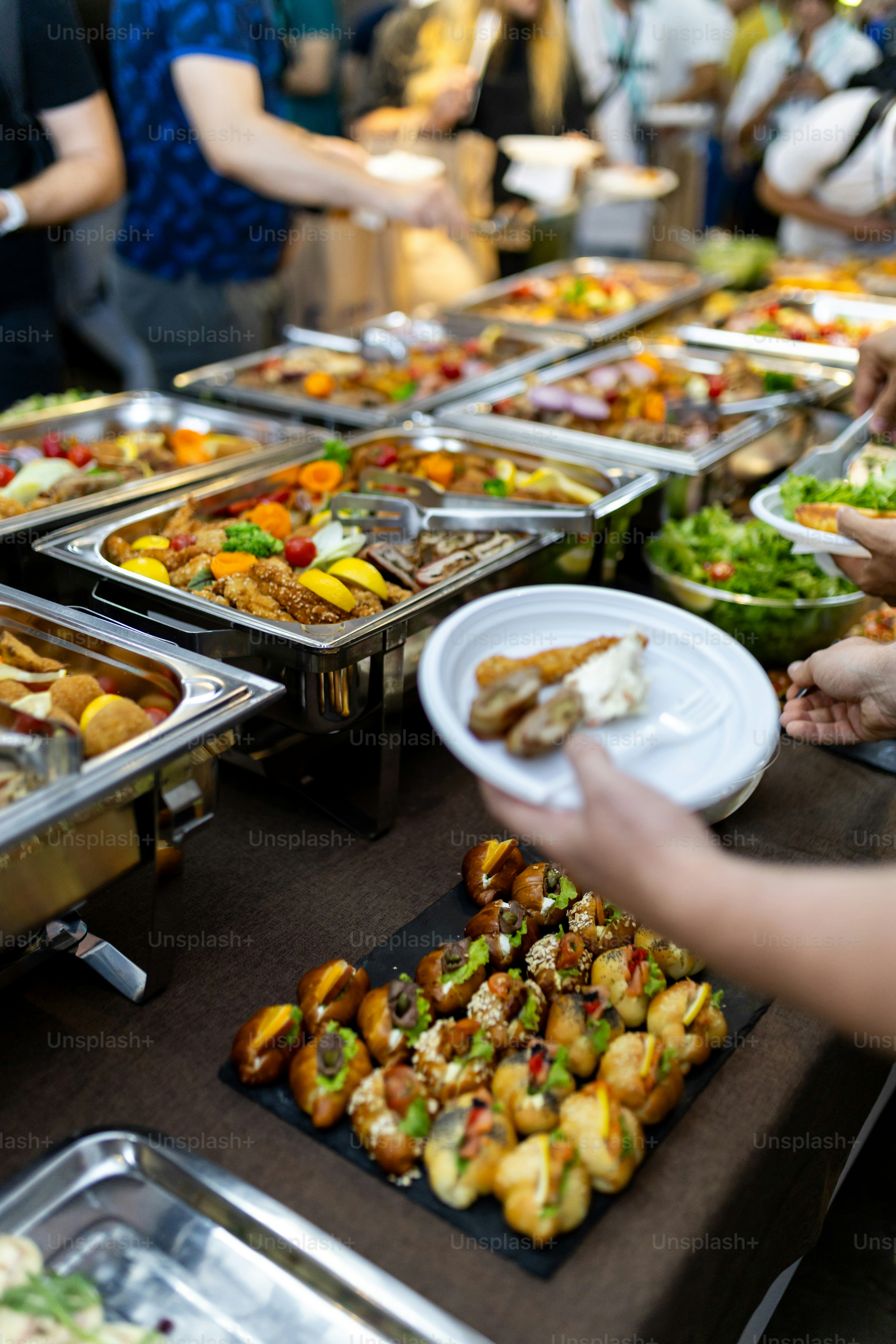 Guests are enjoying a buffet with an array of dishes, including salads ...