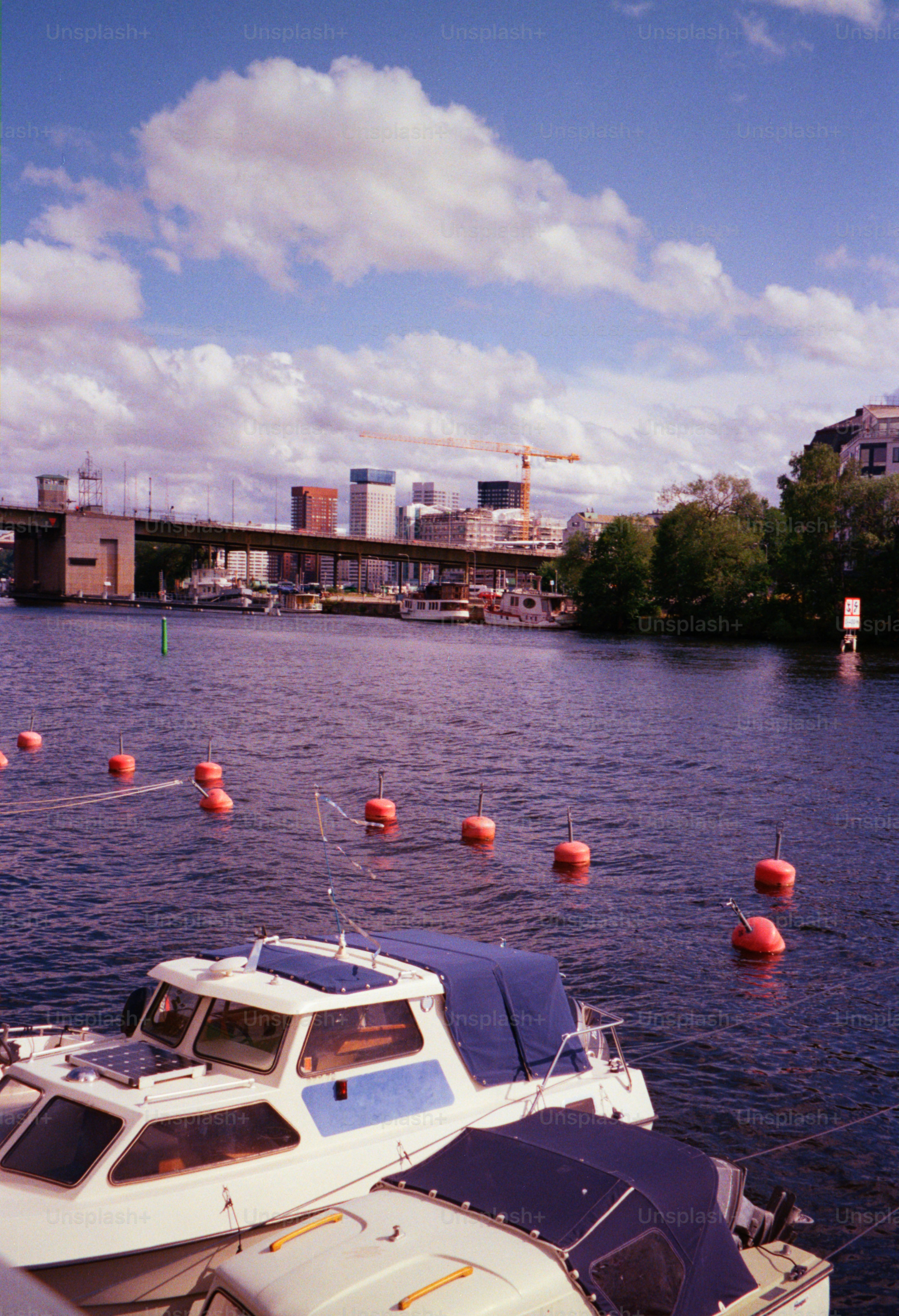Boats are anchored in a tranquil body of water. photo – Transportation ...