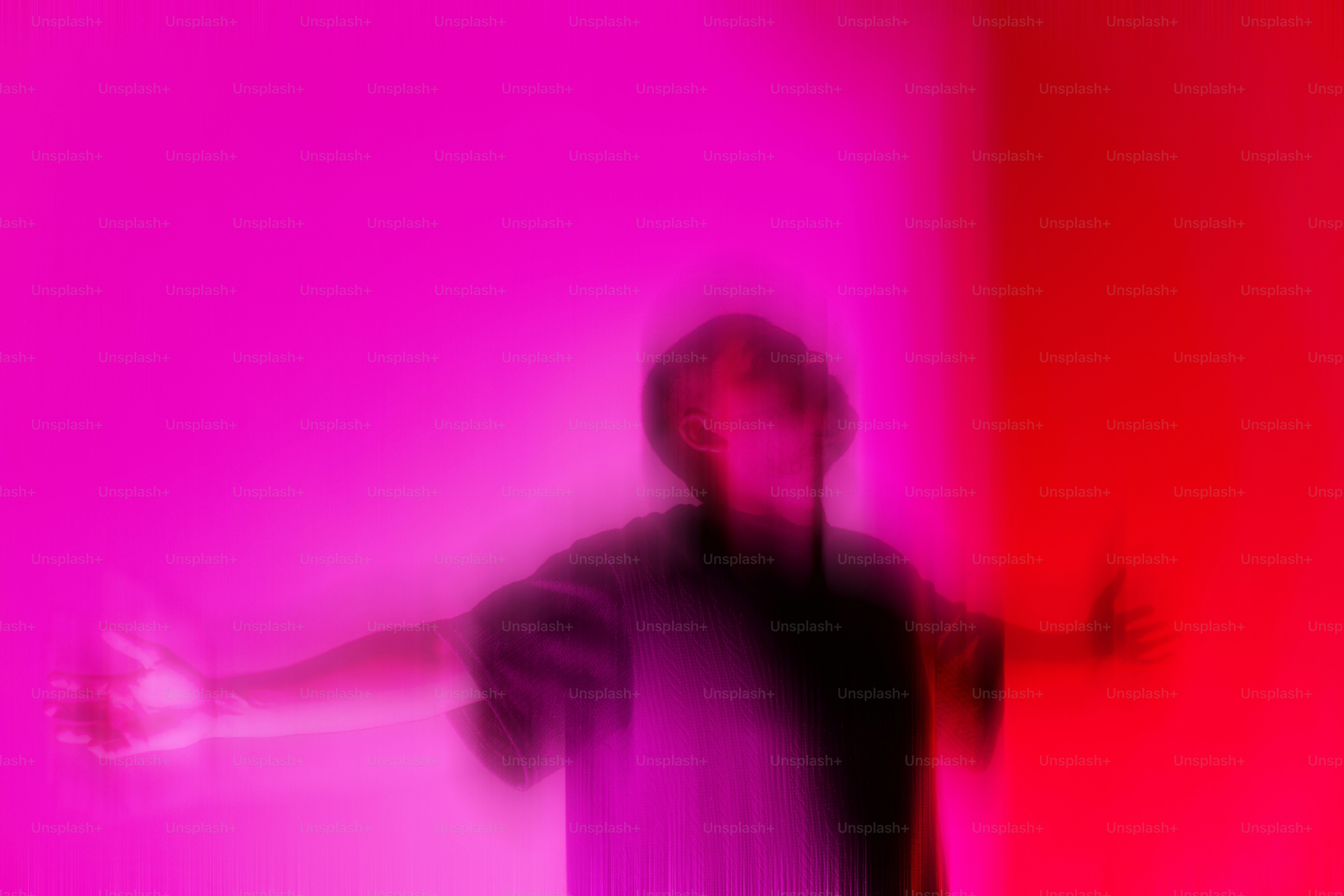 A blurry figure with arms outstretched in vibrant colors. photo ...