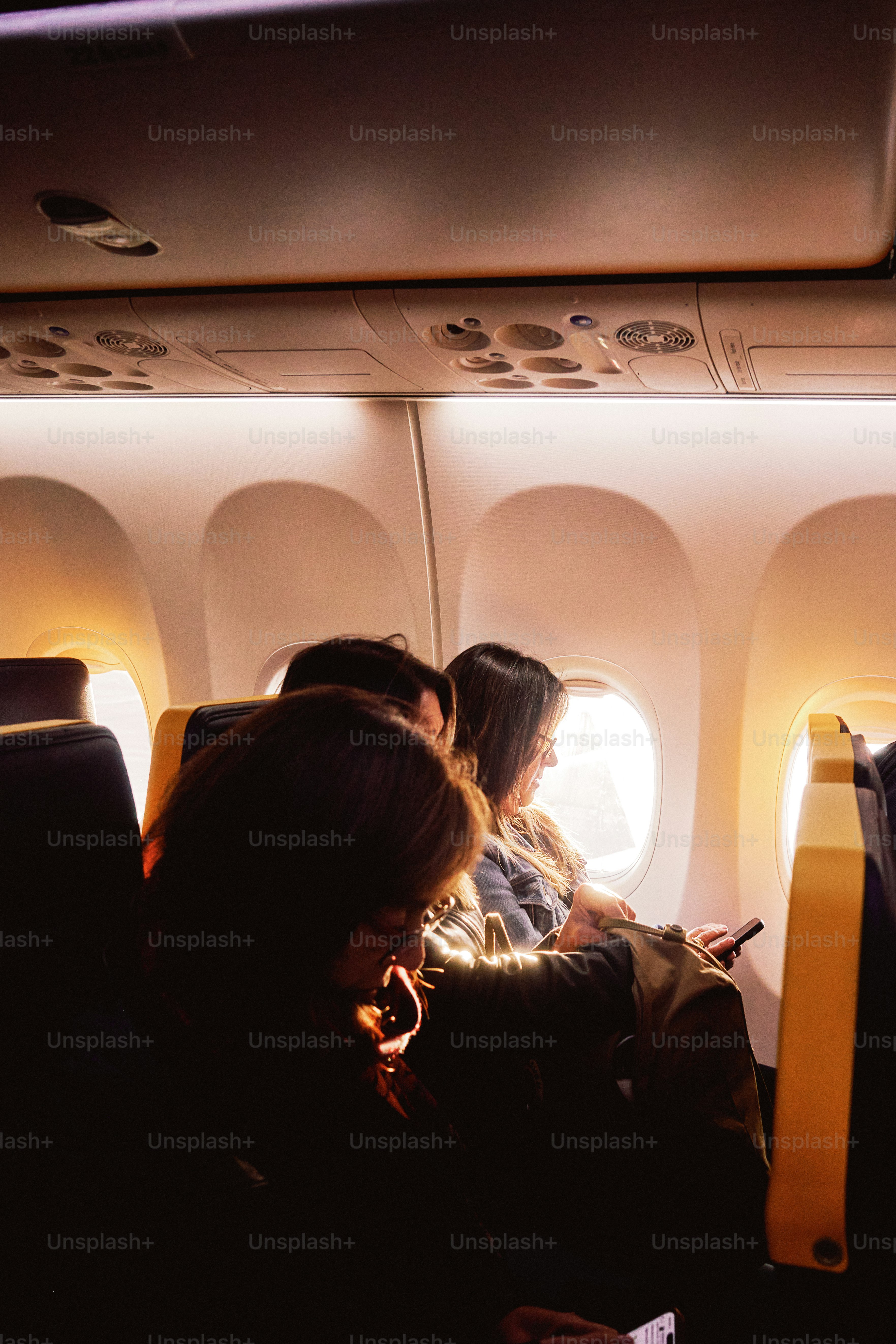Passengers inside an airplane during flight. photo – Travel Image on ...