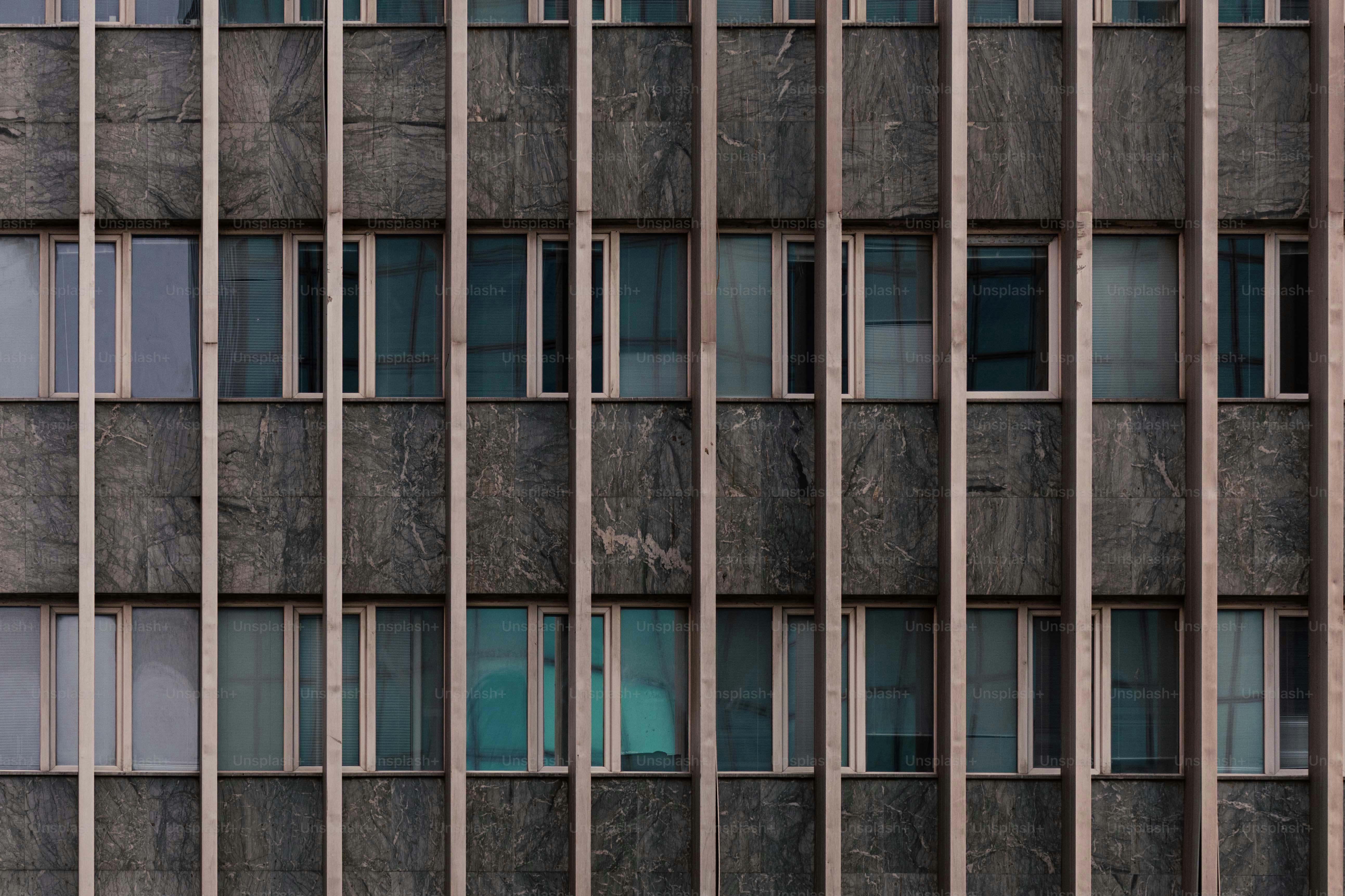 Modern building facade with repeating windows and vertical lines photo ...