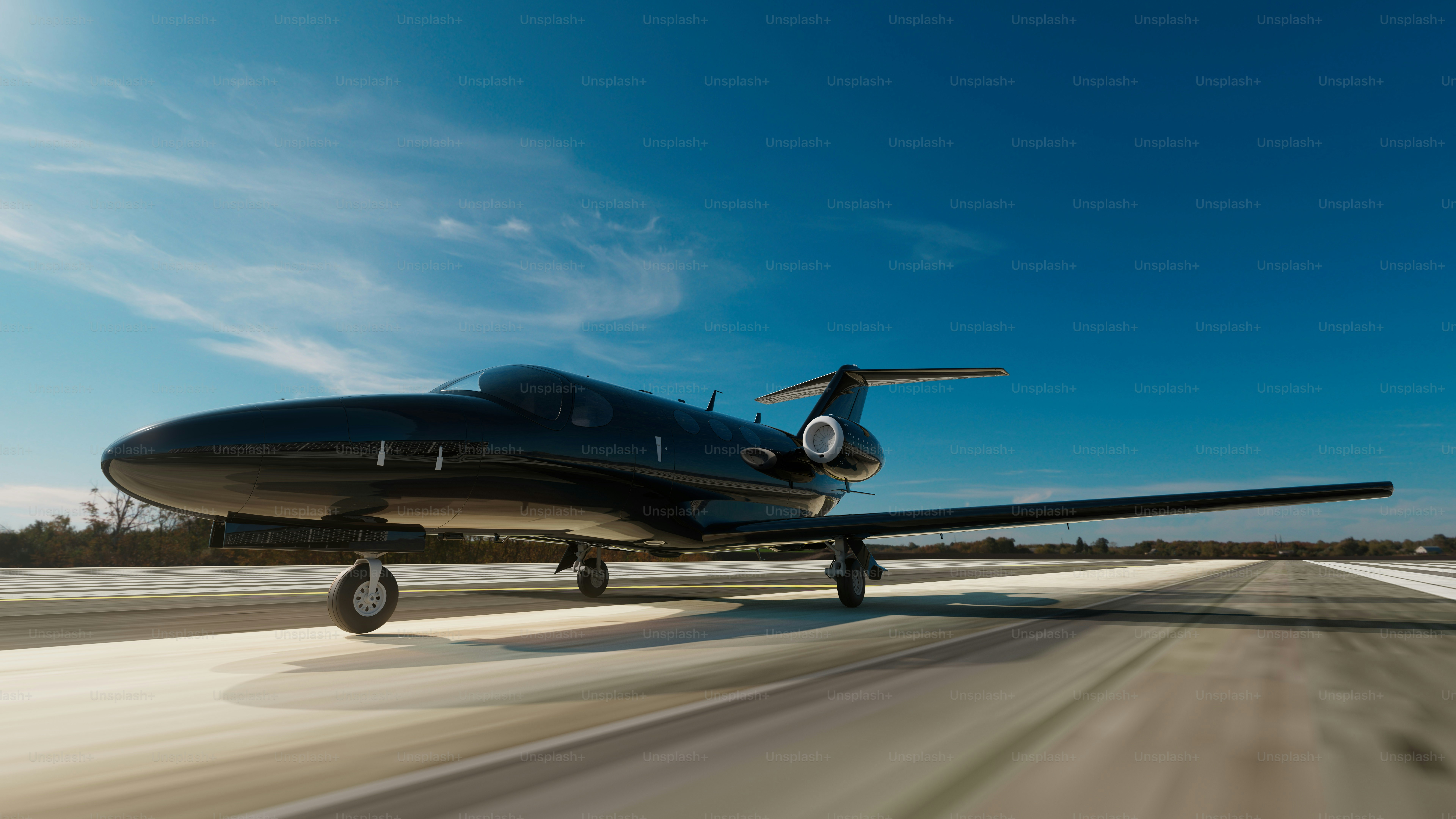 A sleek, dark airplane on a runway under a blue sky. photo – Travel ...