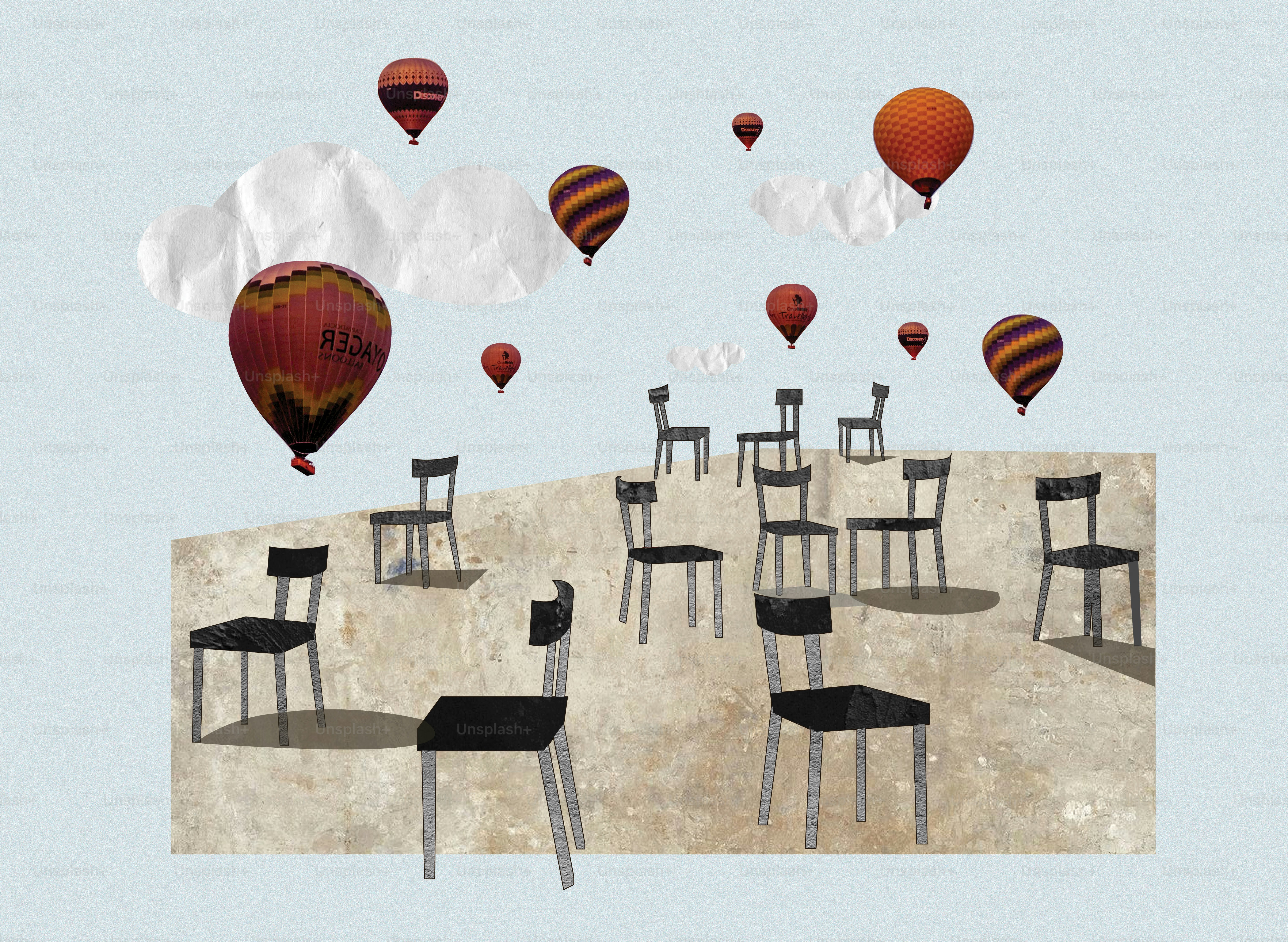 Hot air balloons float above chairs on a textured surface. photo ...