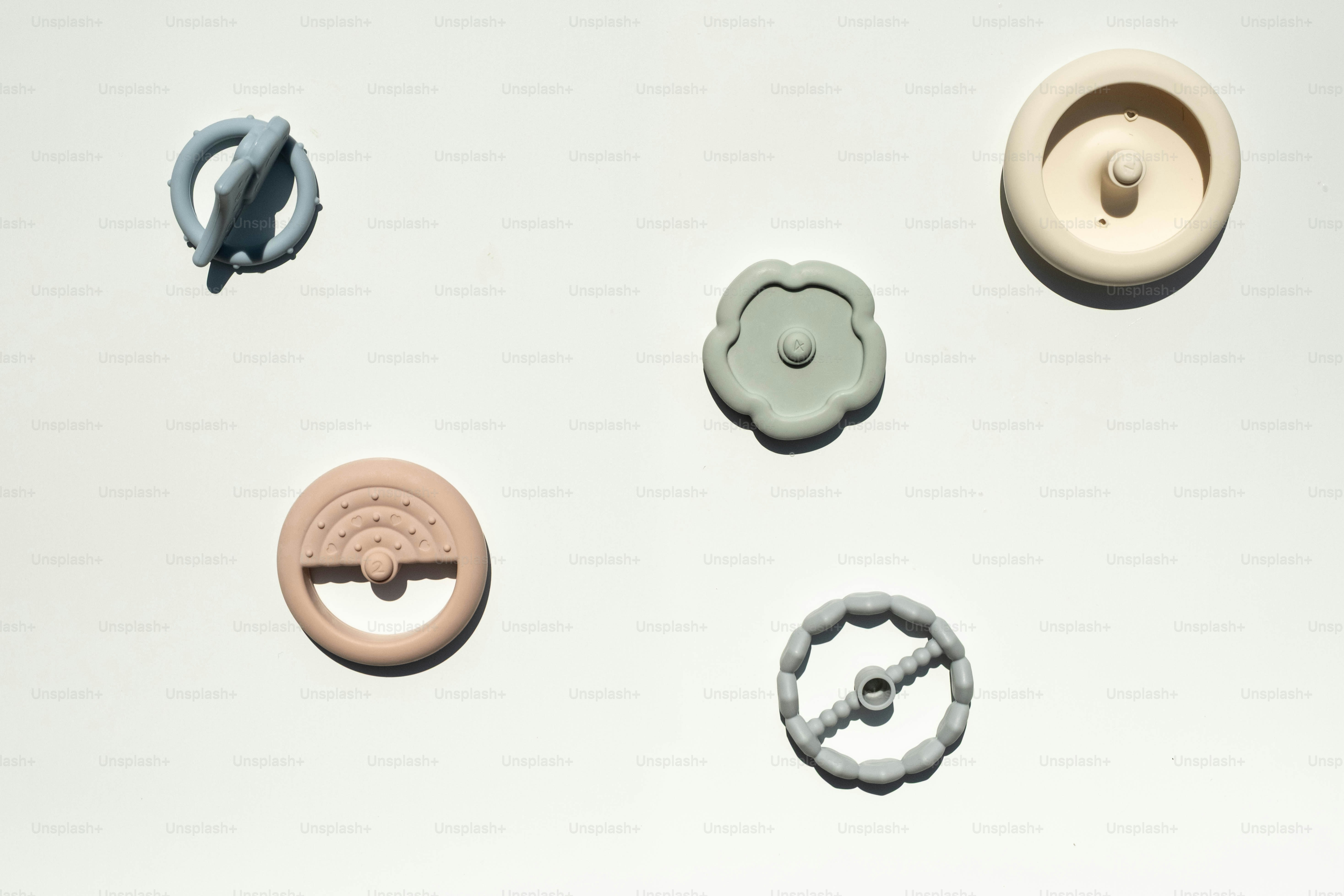 Five different shaped silicone molds on white background photo ...