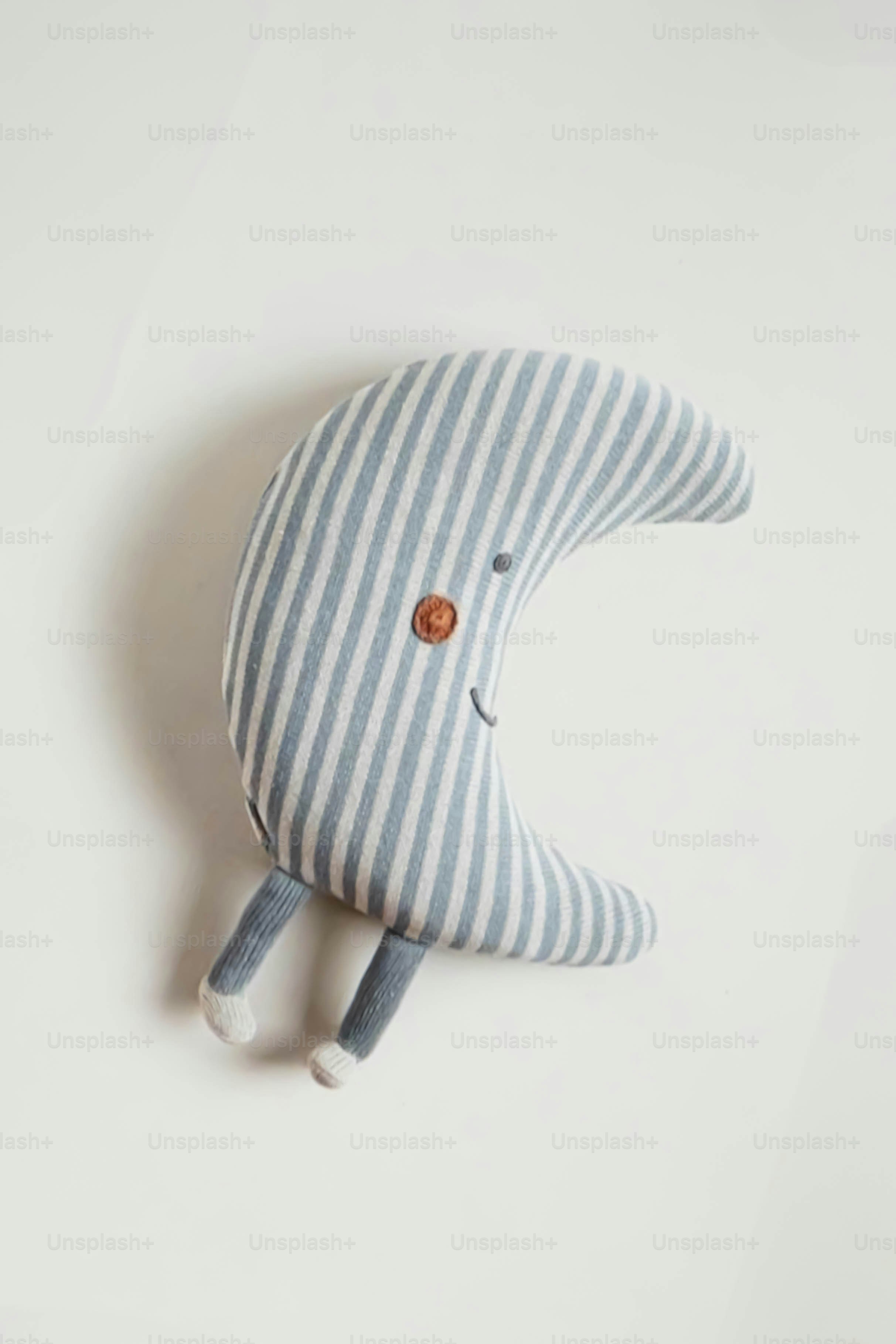 A plush crescent moon toy with striped fabric. photo – Comfort Image on ...