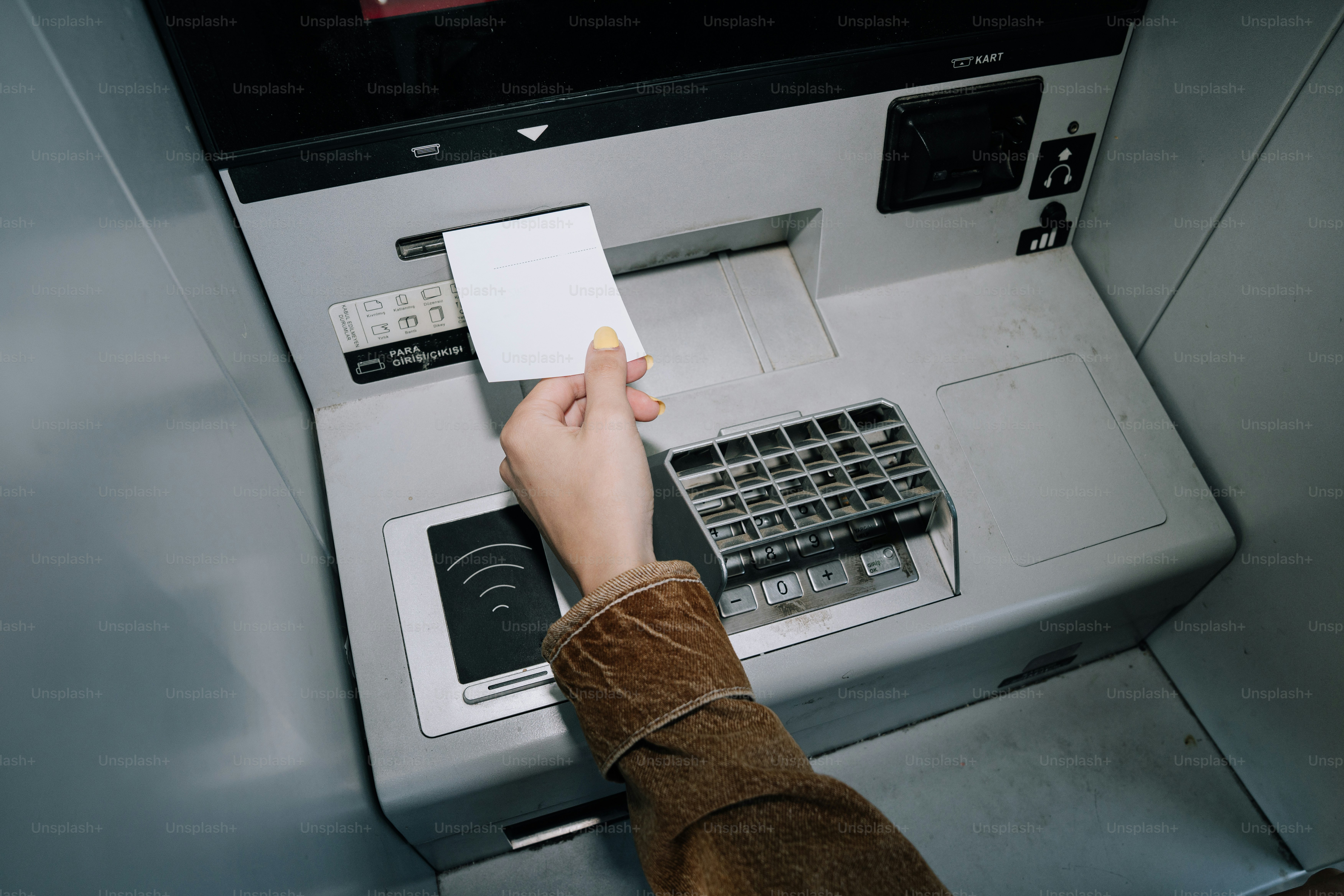 Hand inserting banknotes into an atm machine. photo – Money Image on ...