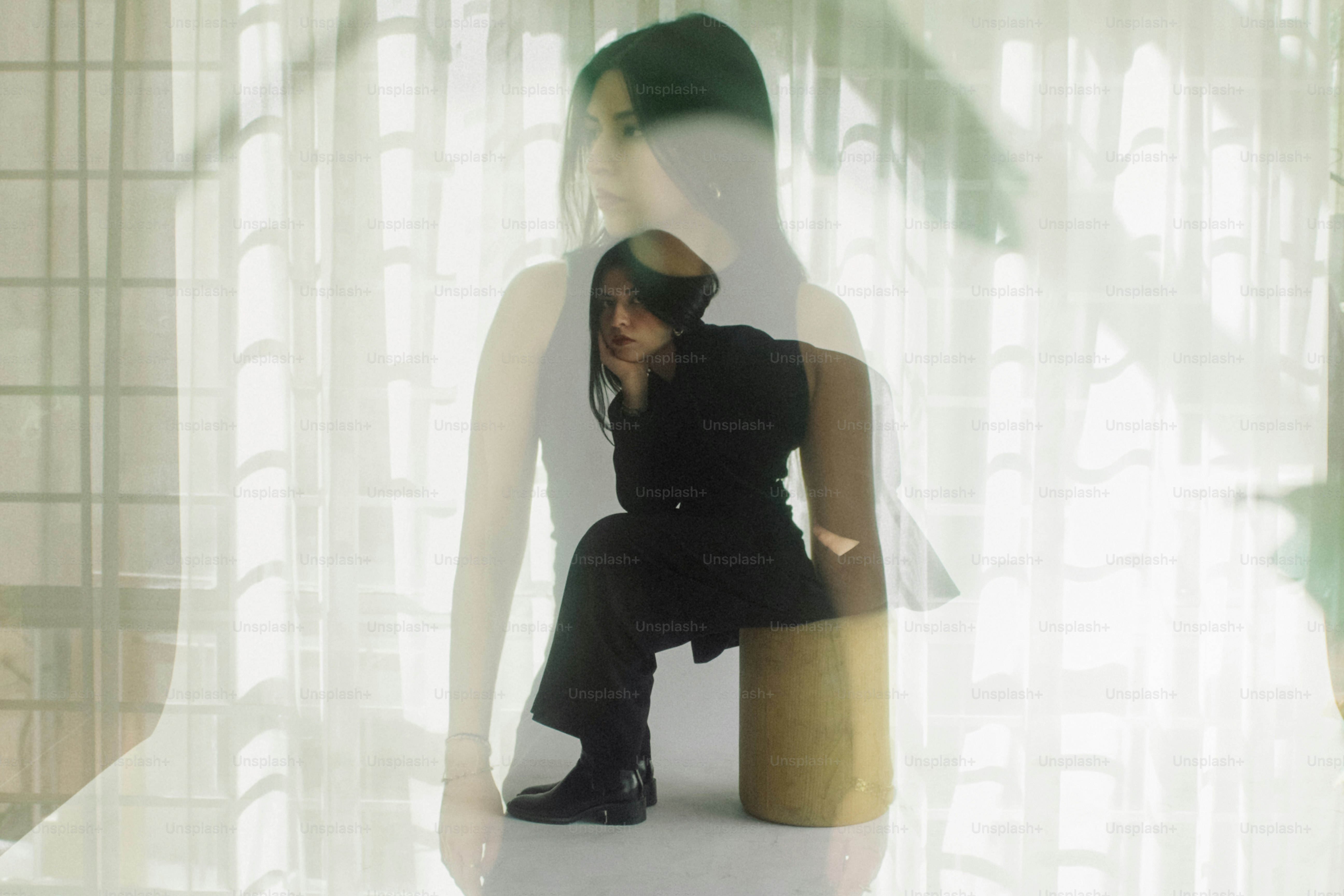 Woman in black sitting with layered translucent effect photo ...