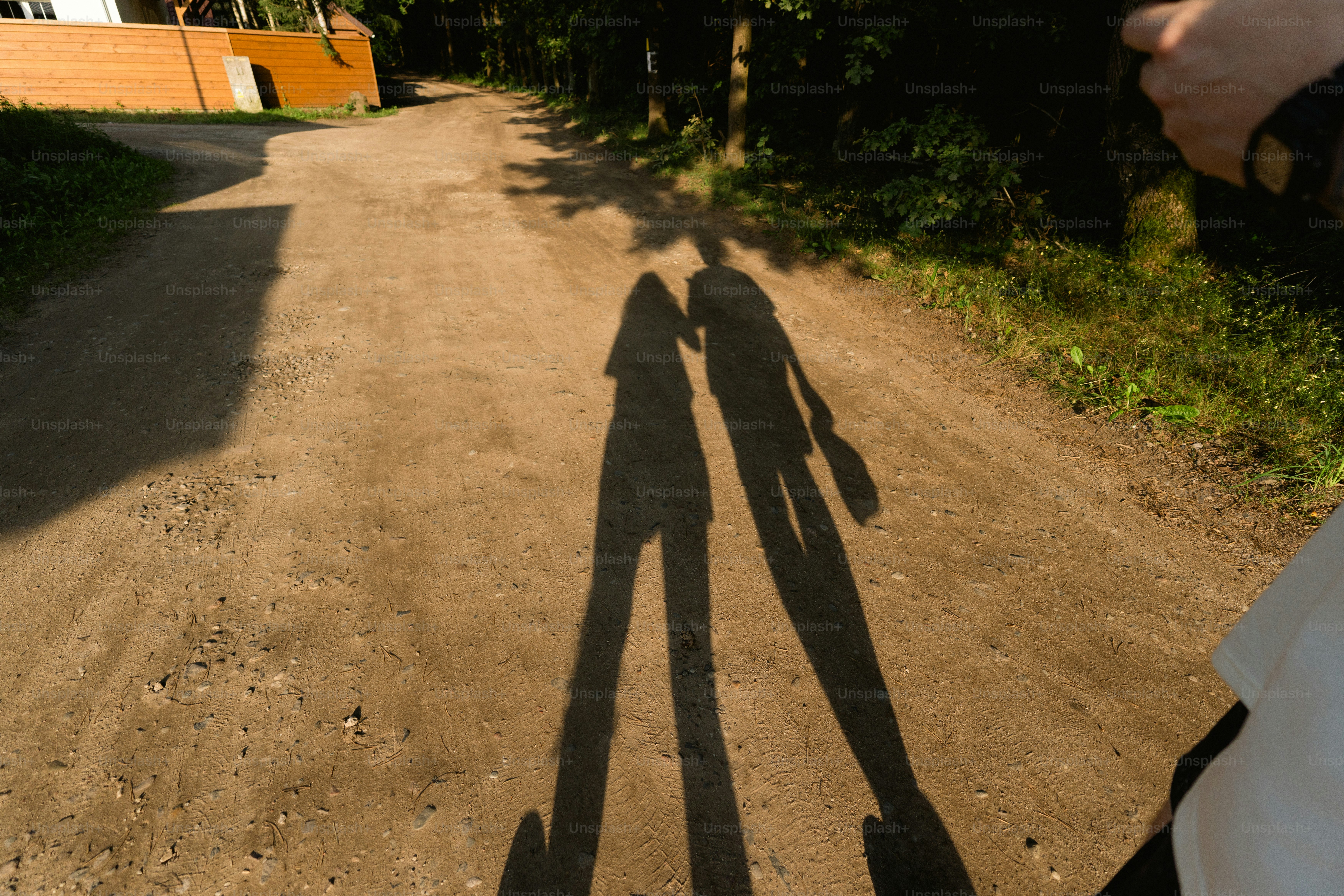 Two people's shadows on a dirt road photo – Travel Image on Unsplash