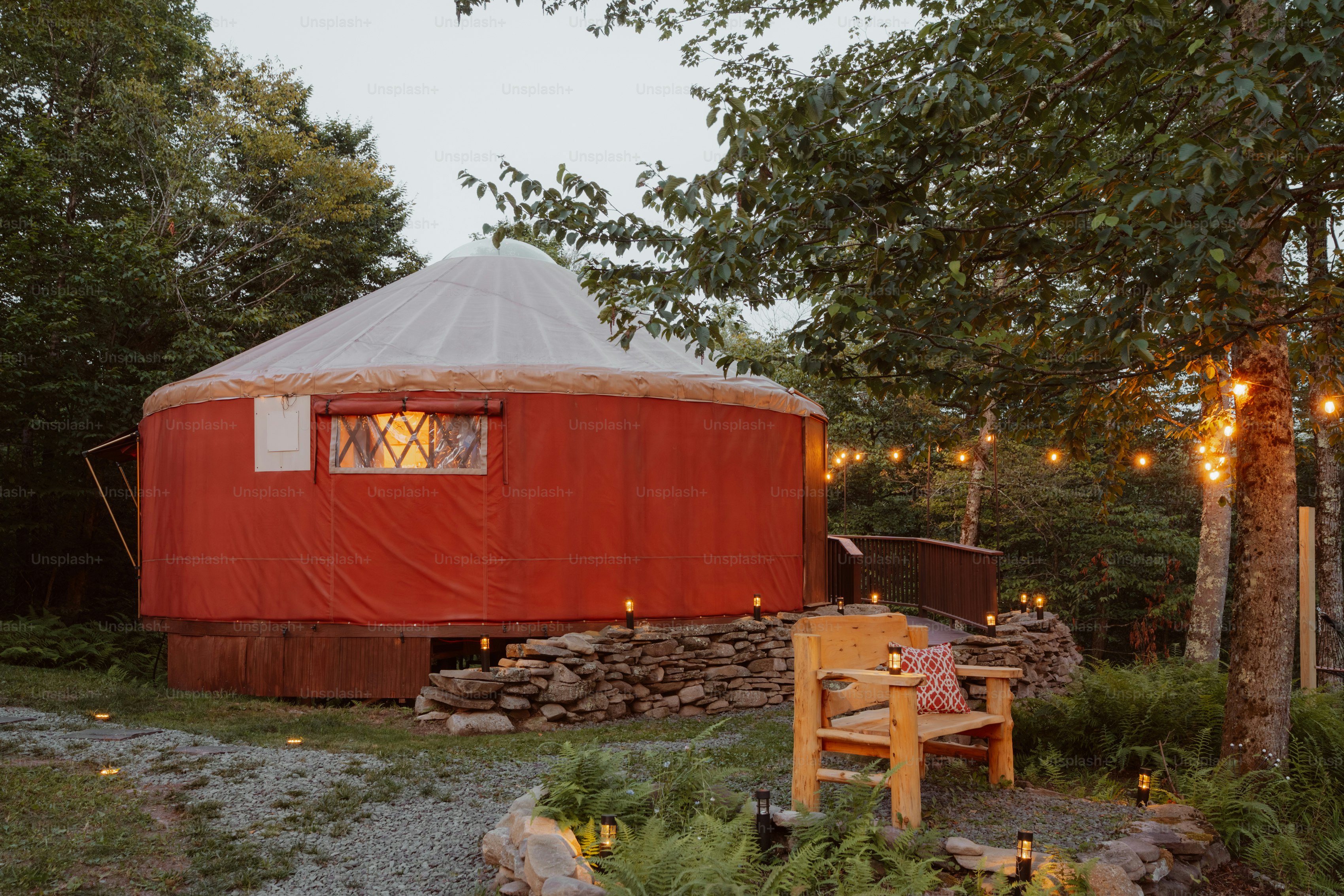 Red yurt illuminated by string lights and candles photo – House Image ...