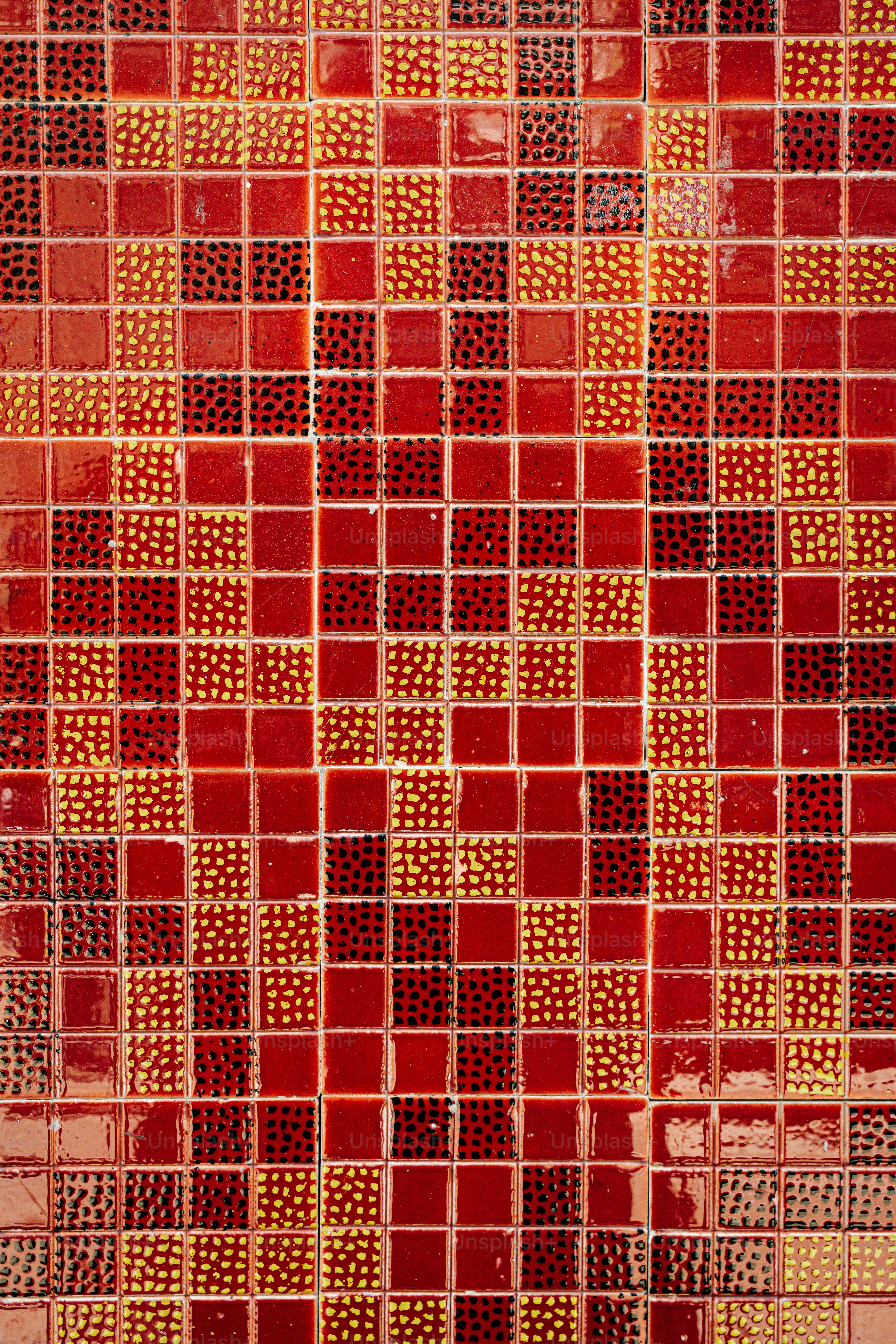 Red and yellow square mosaic tiles with textured patterns. photo ...