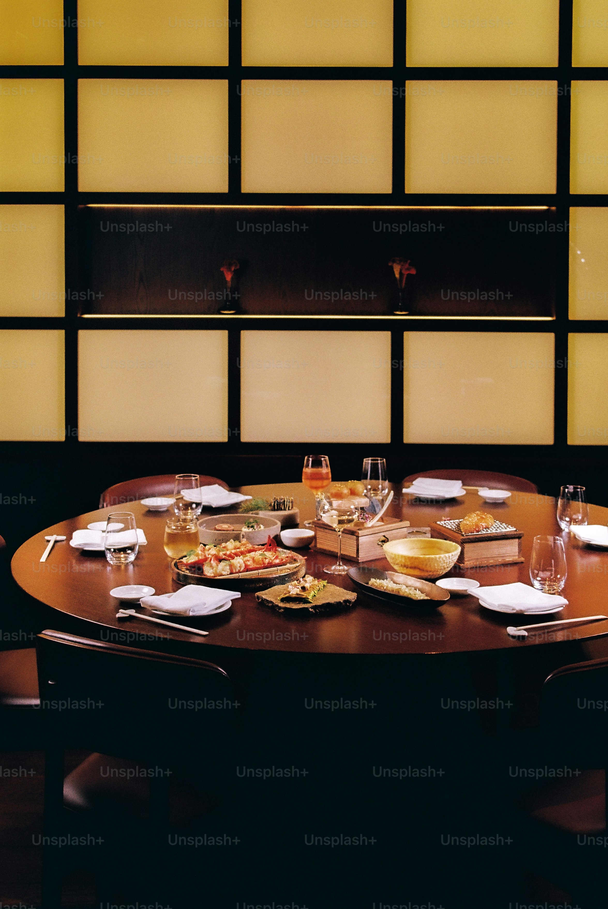 Round dining table set with various dishes and drinks. photo ...