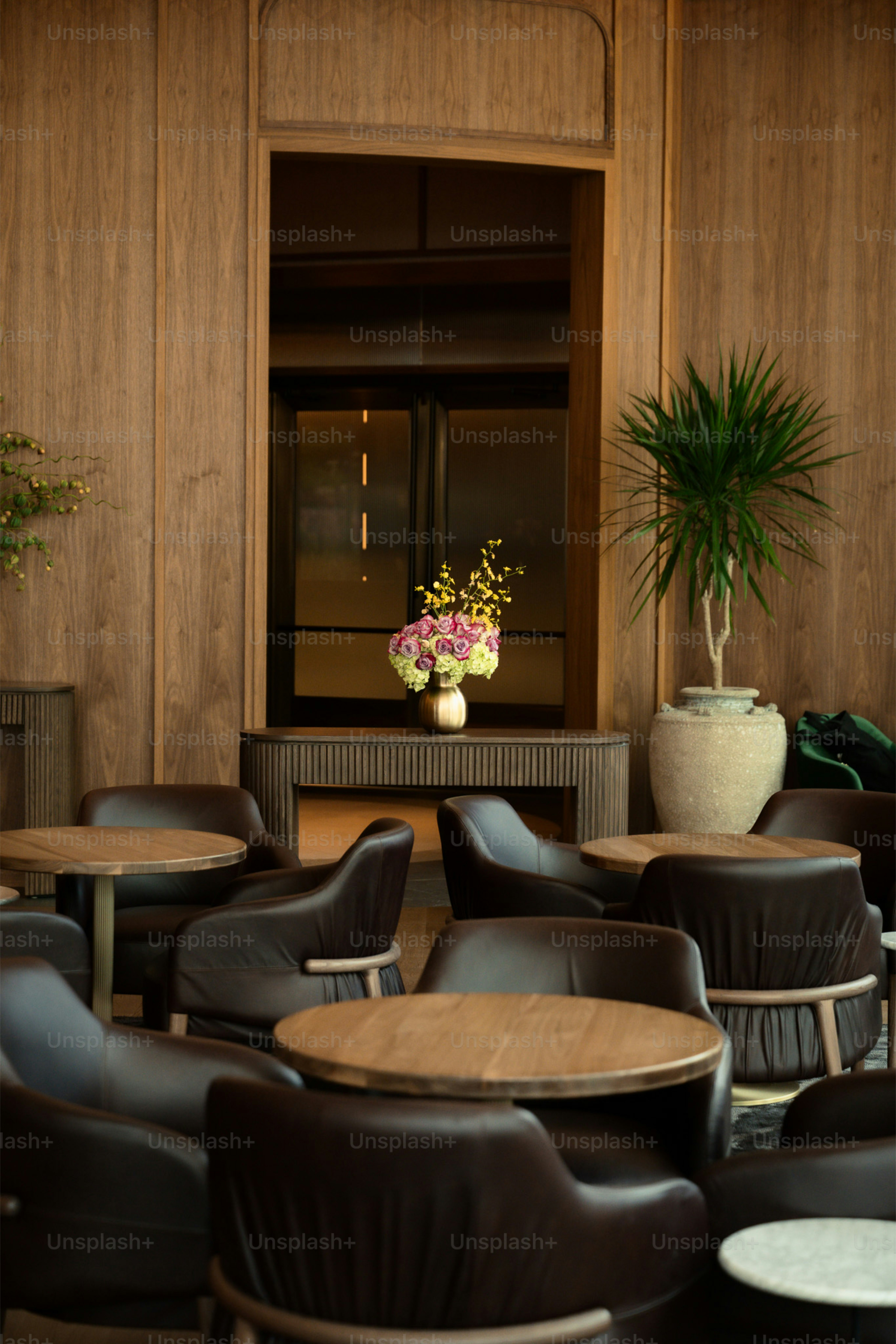 Modern lounge area with leather chairs and wooden tables. photo ...