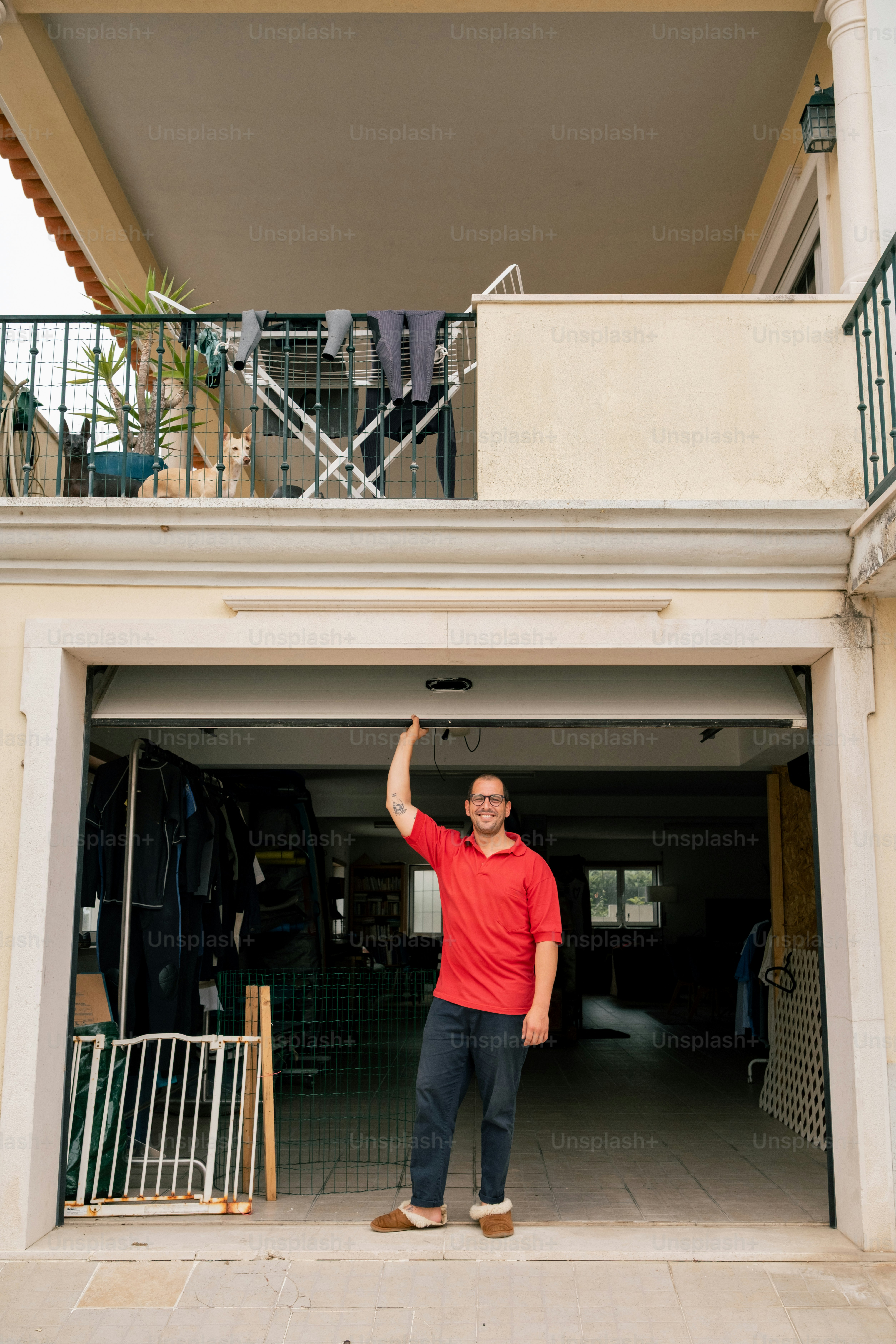 Man in red shirt standing outside a house. photo – Portrait Image on ...