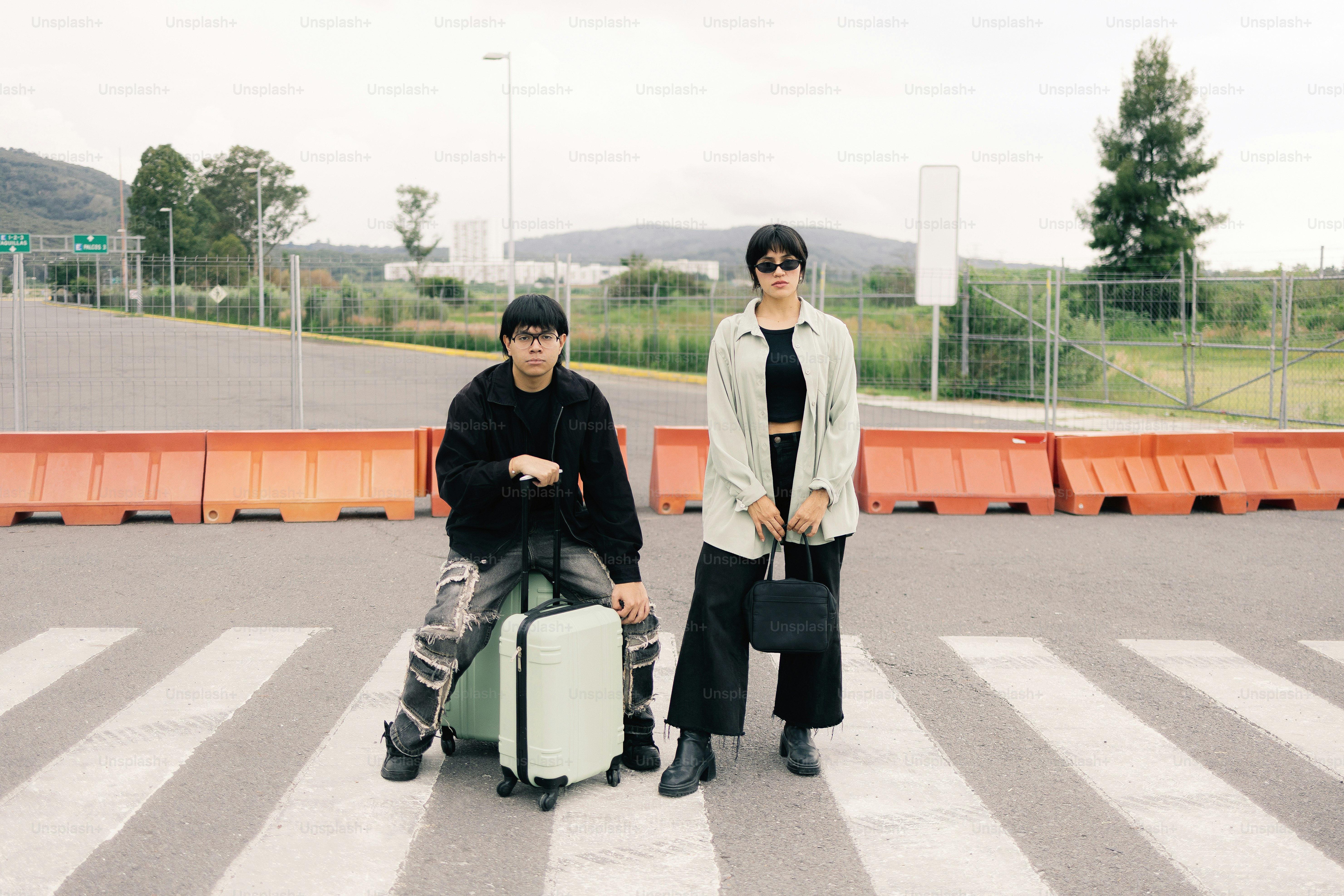 Two people with luggage on a crosswalk photo – Adventure Image on Unsplash
